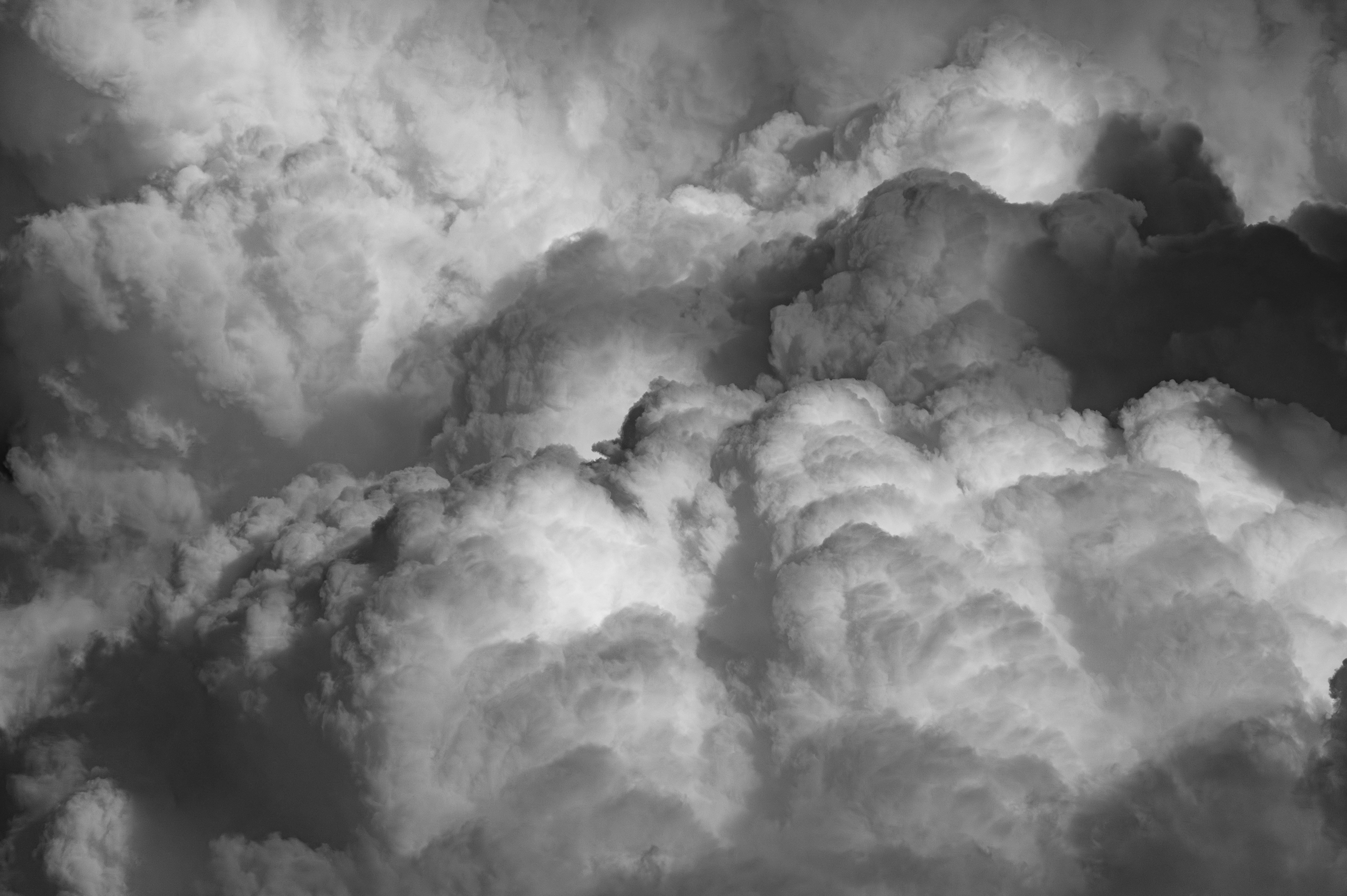 Dramatic black and white clouds forming turbulent patterns in the sky.