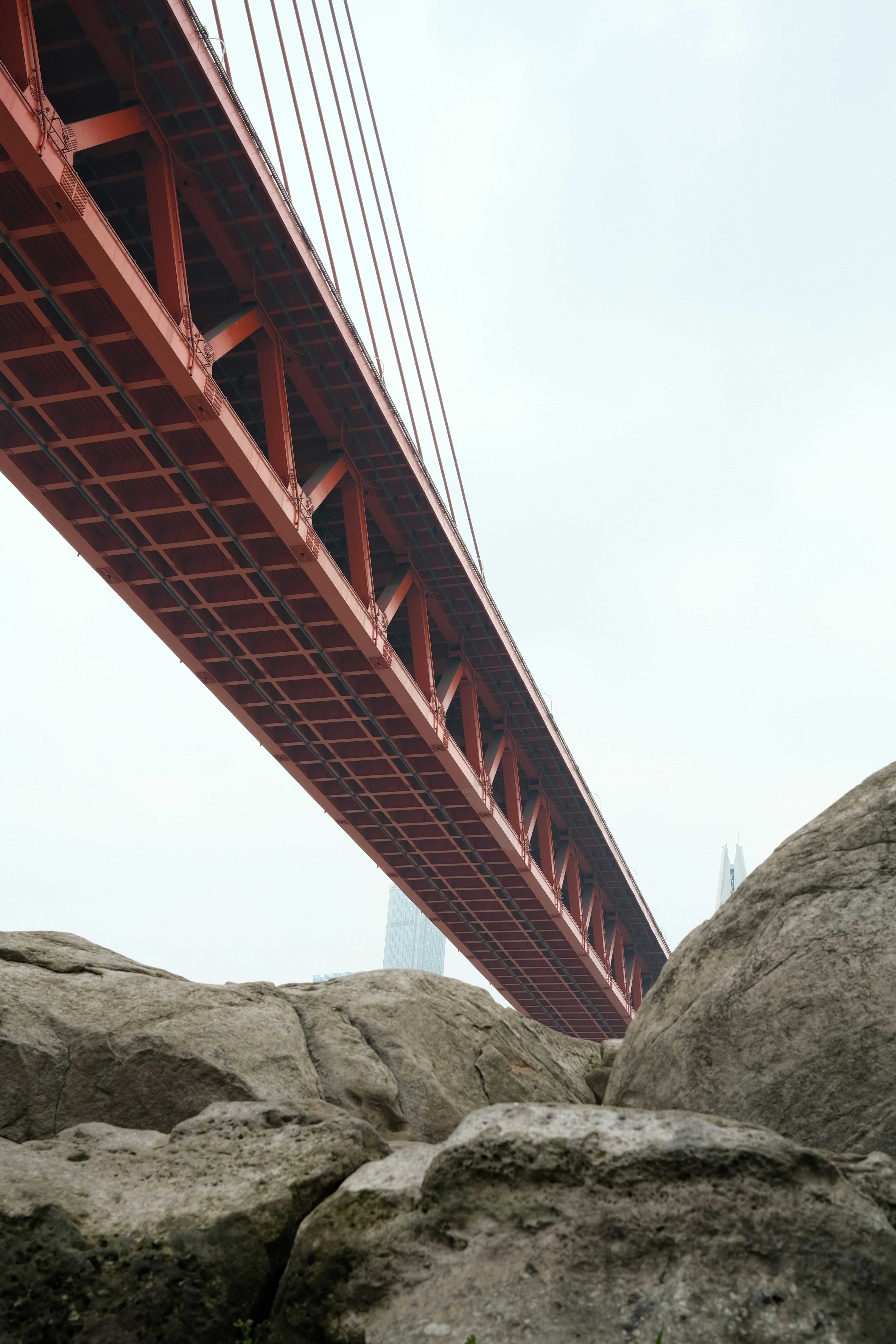 Crimson Trusses Over Granite: A Low-Angle Bridge Study