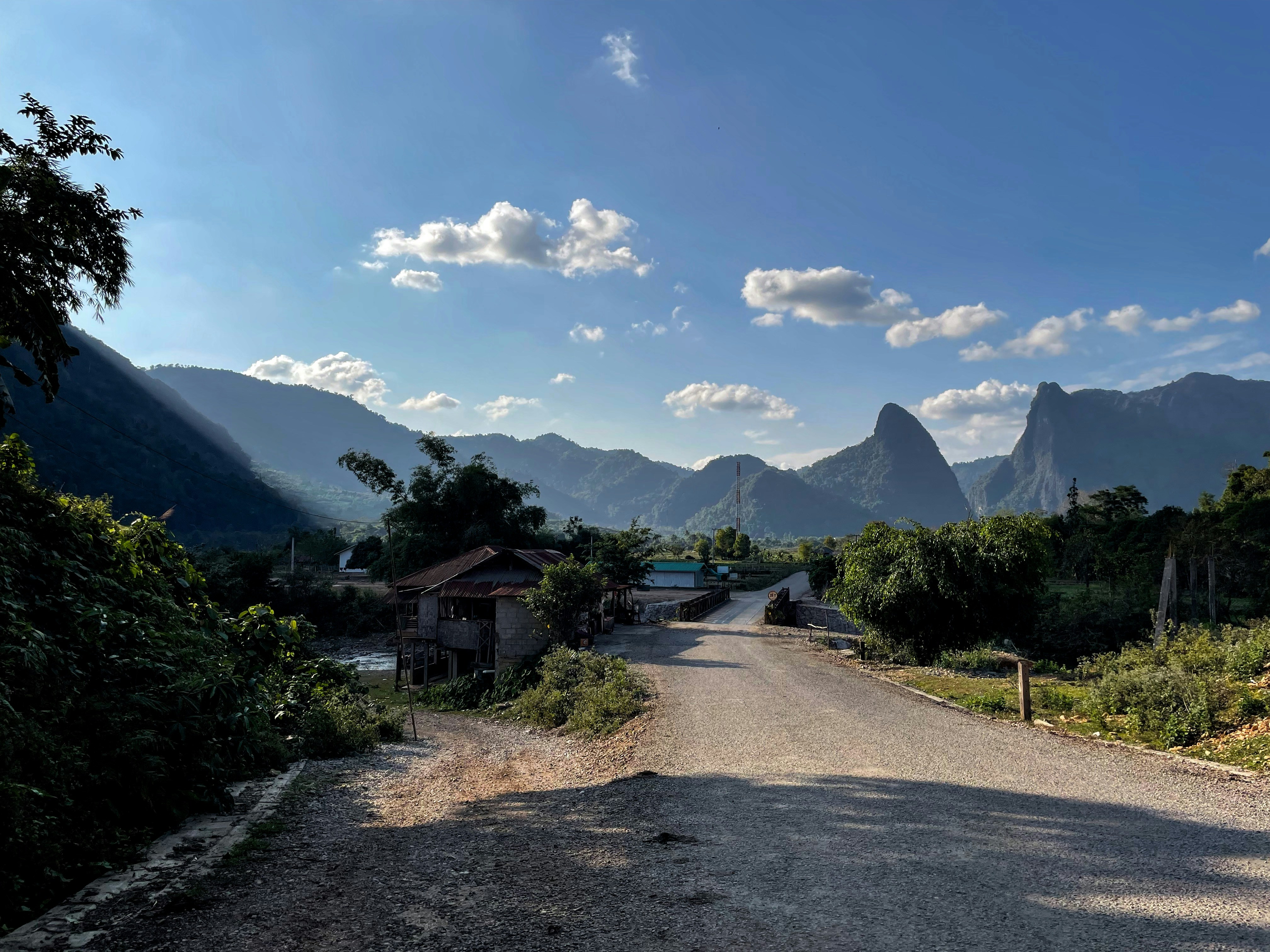 A dirt road with mountains in the background photo – Free Road Image on ...