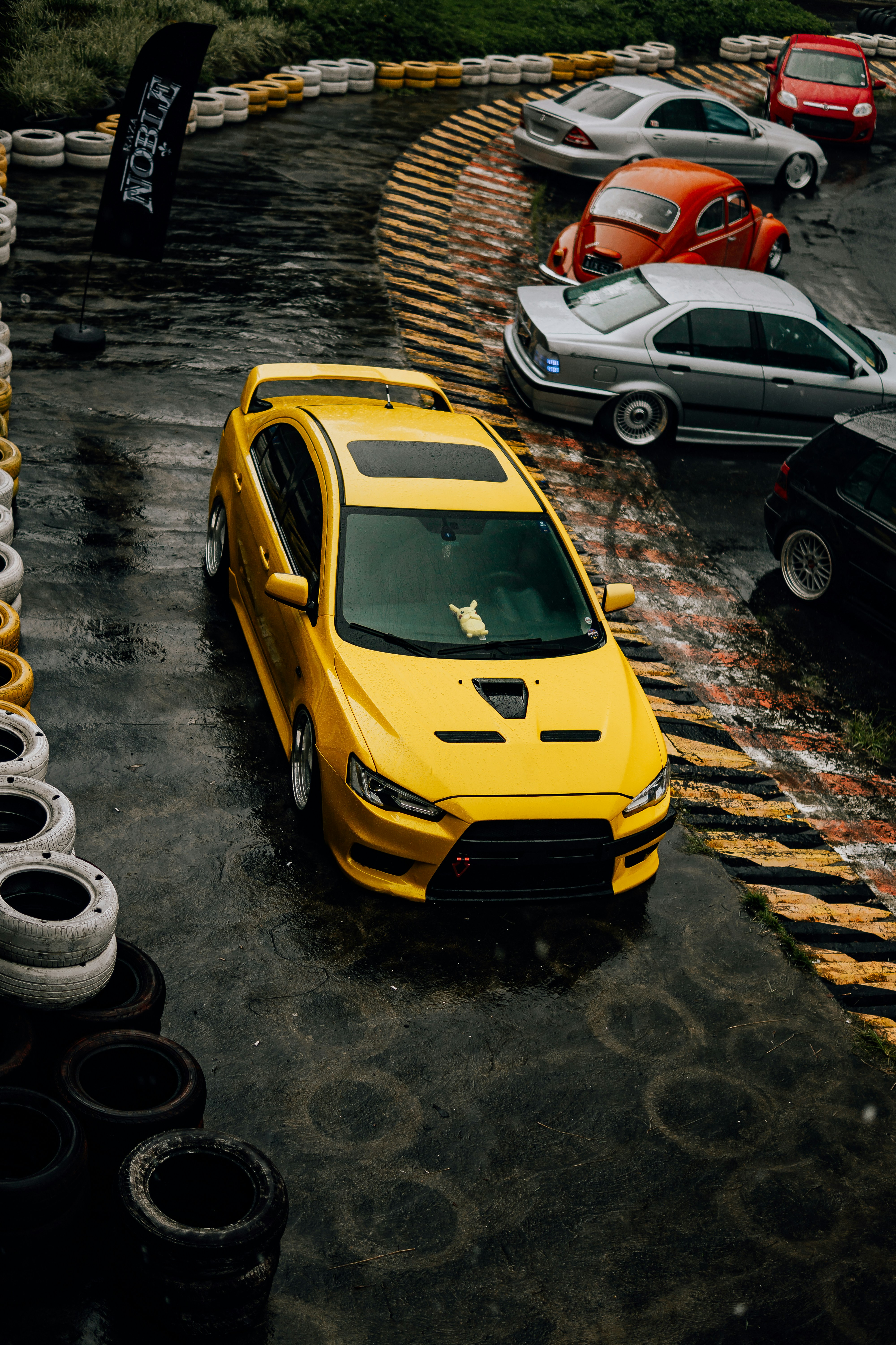 a yellow car is parked in a parking lot
