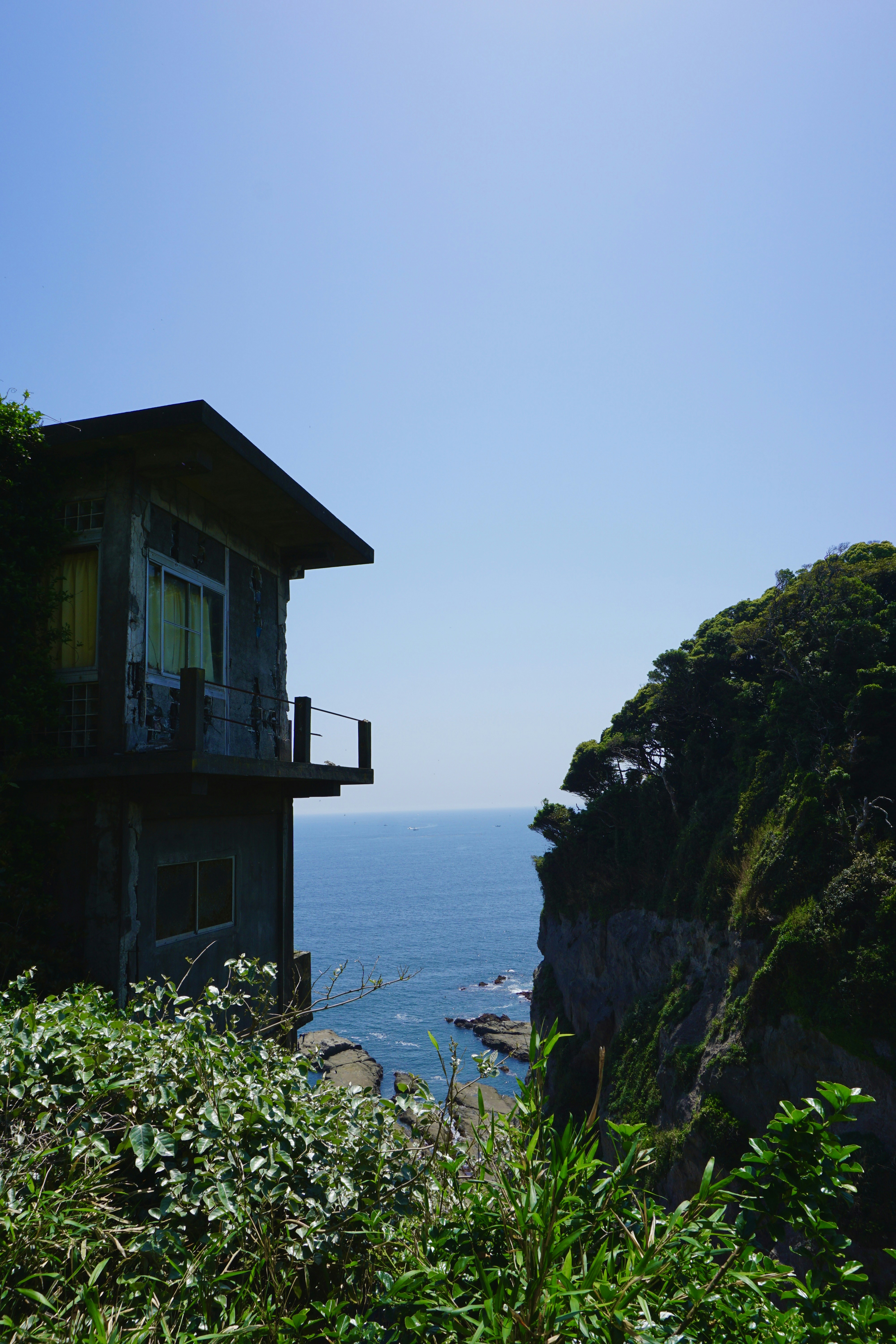 Edgewatch on the Cliff: Weathered House Overlooking the Cerulean Sea