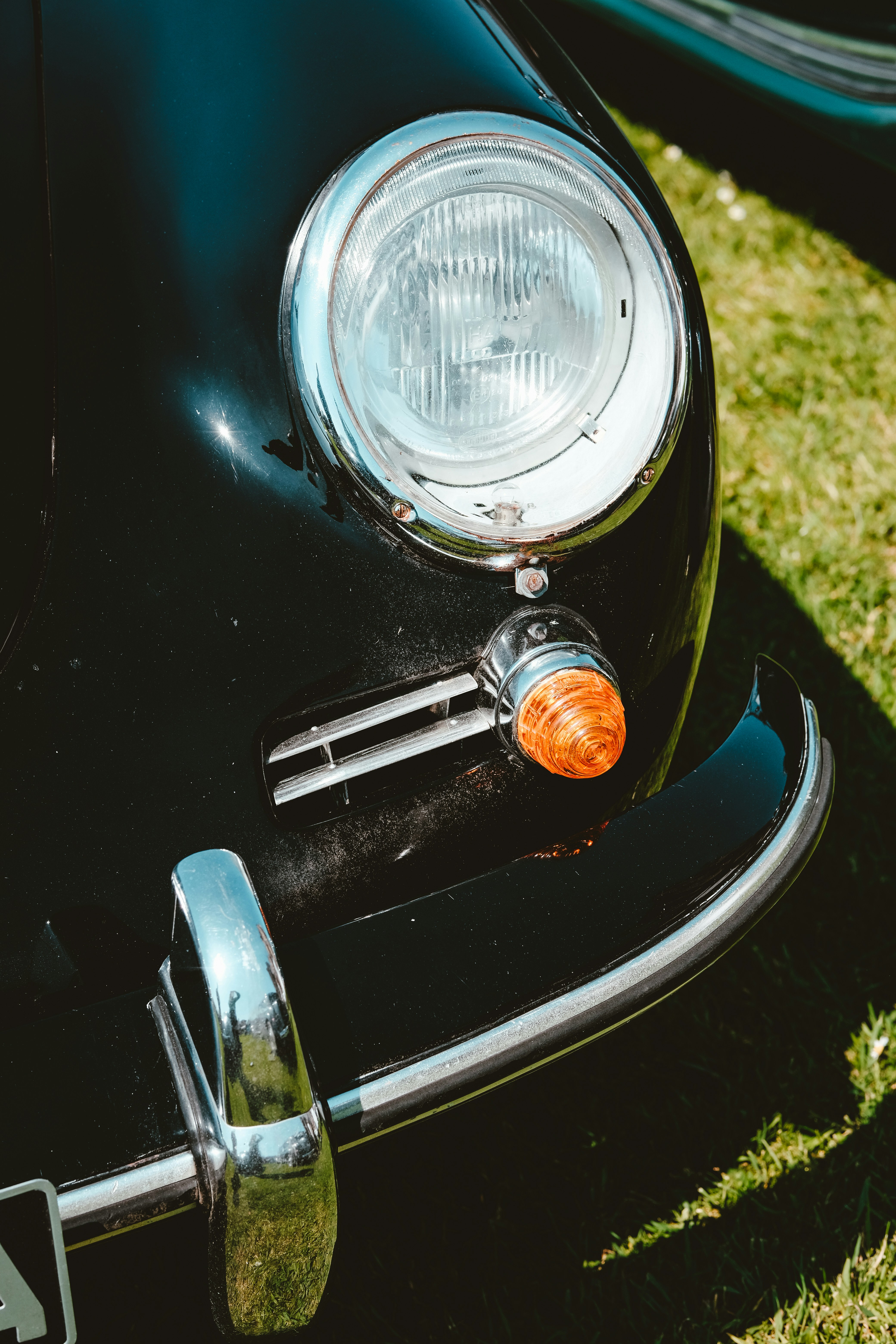 Chromed Headlight and Orange Marker on Classic Black Car