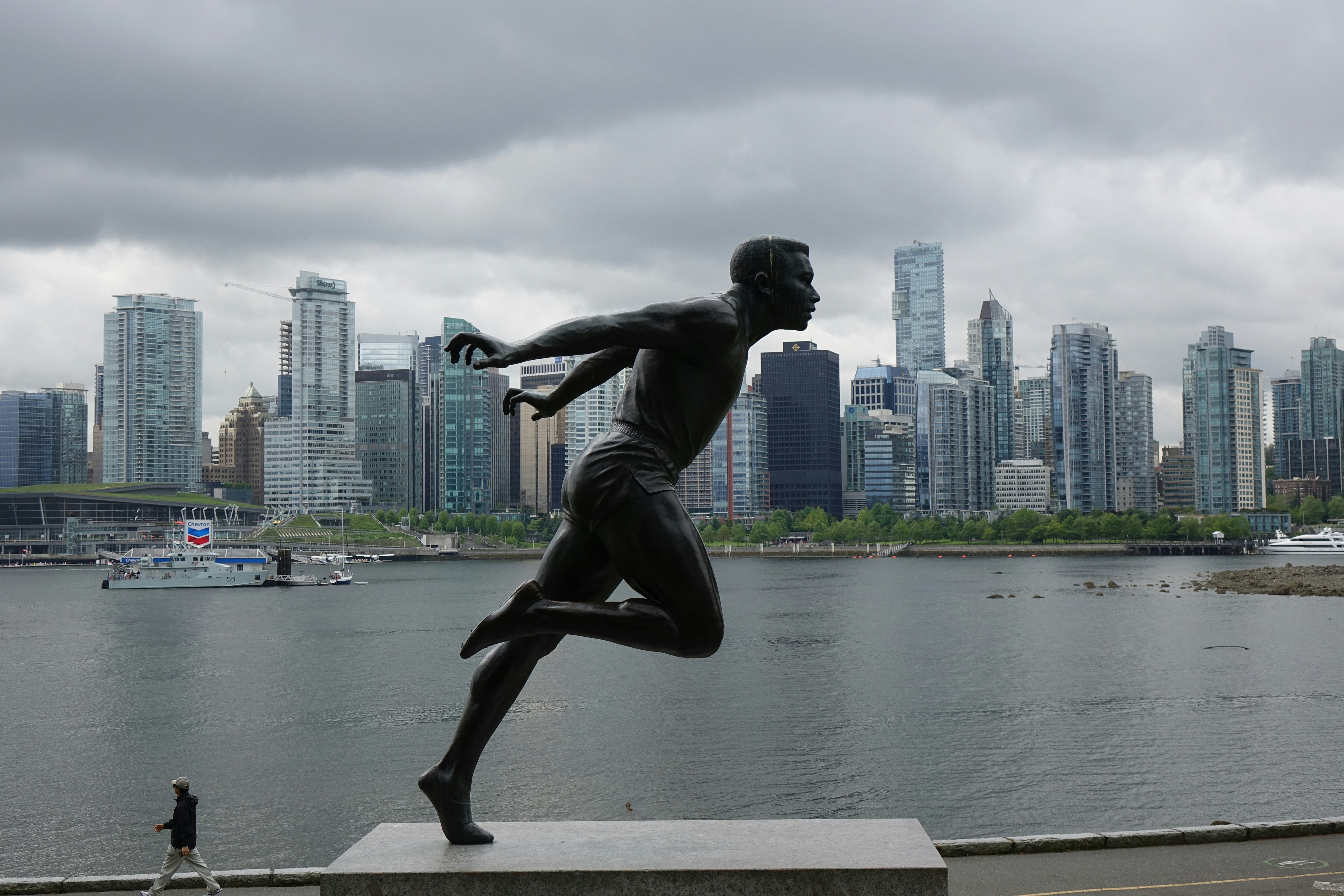 Bronze Sprinter by the Waterfront: Stride Against a Moody Vancouver Skyline