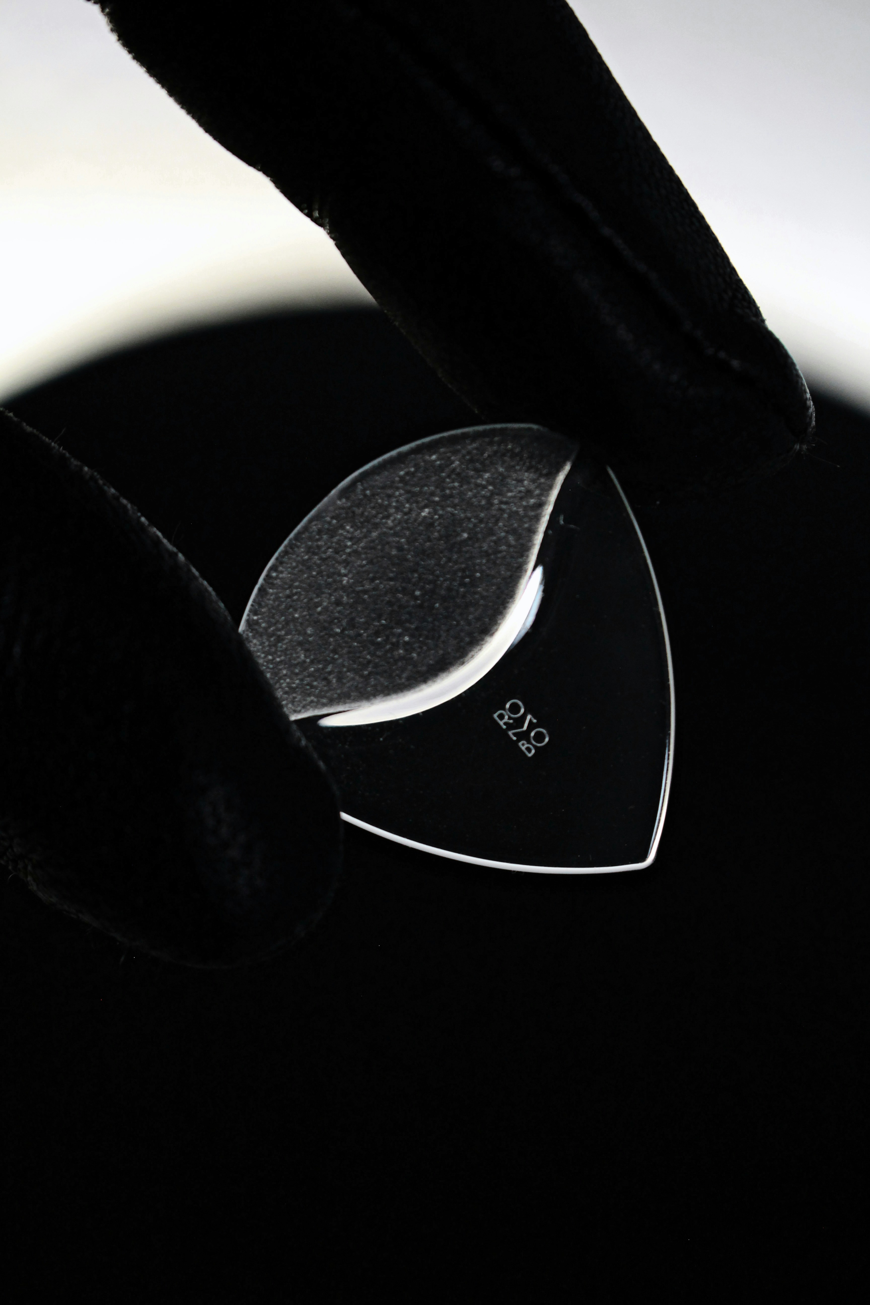 A close up of a guitar pick with a black background photo – Free ...