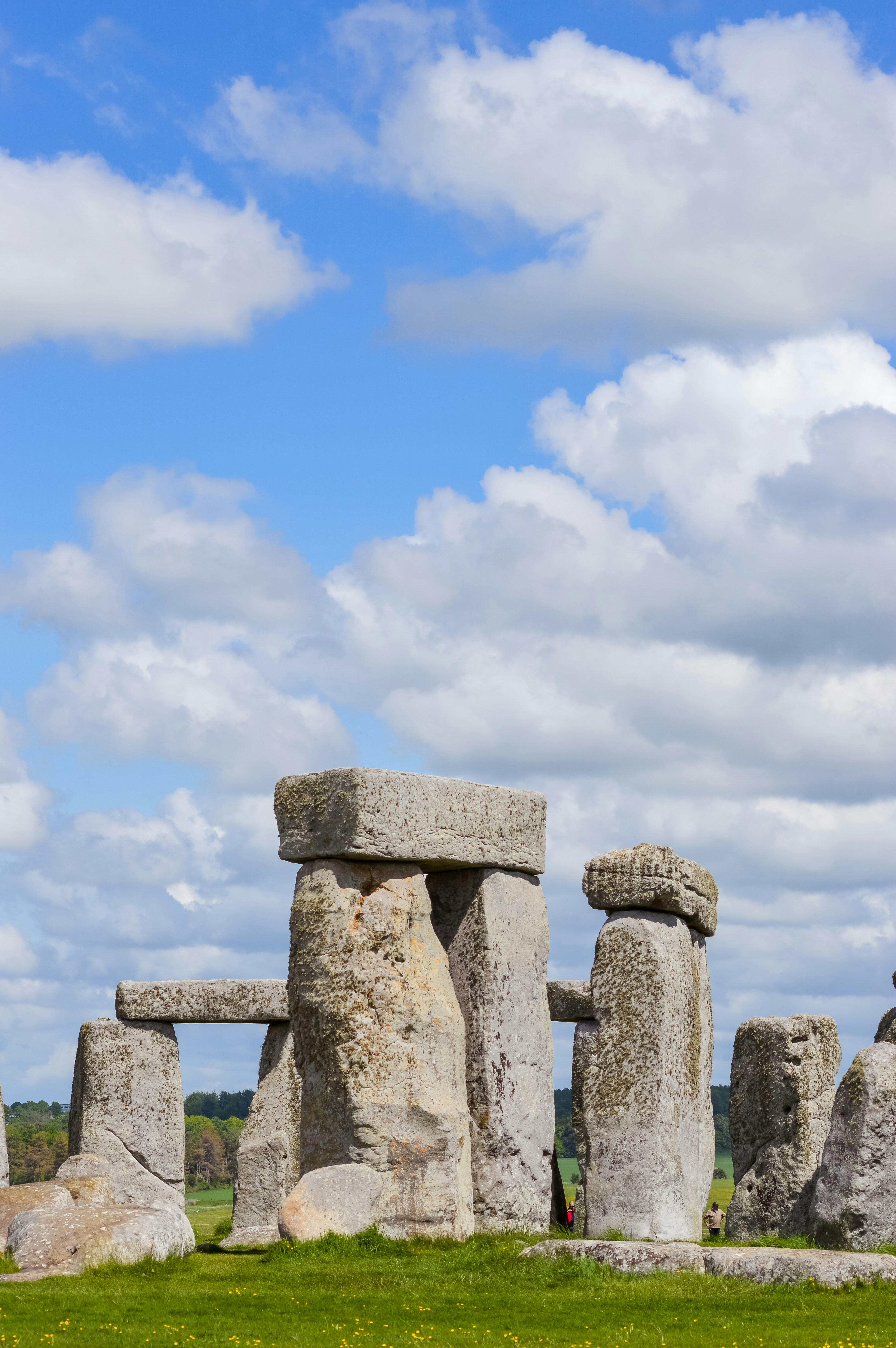 A large stone structure sitting on top of a lush green field photo ...