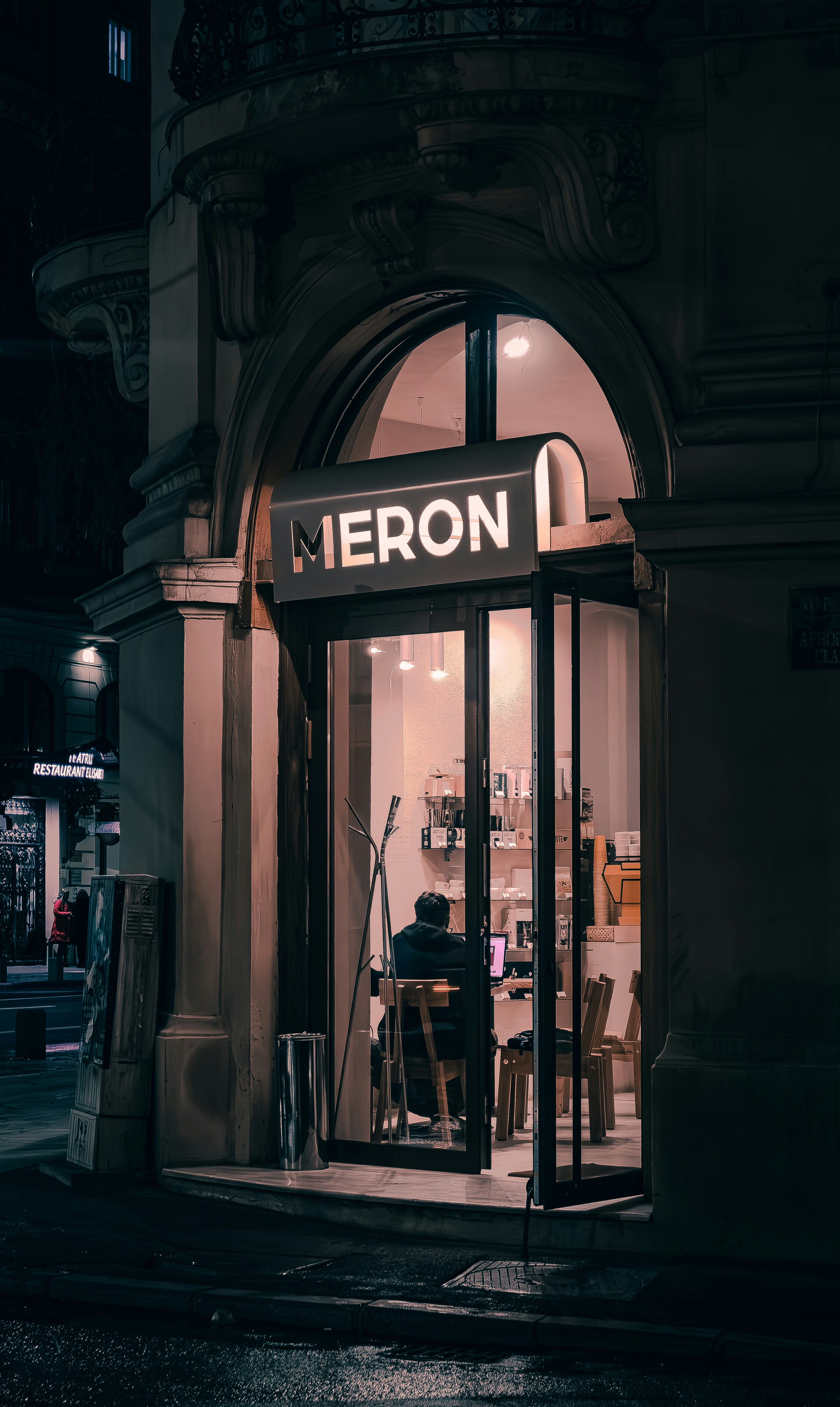 Meron Under the Arch: Warm Light Framing a Quiet Night Shift