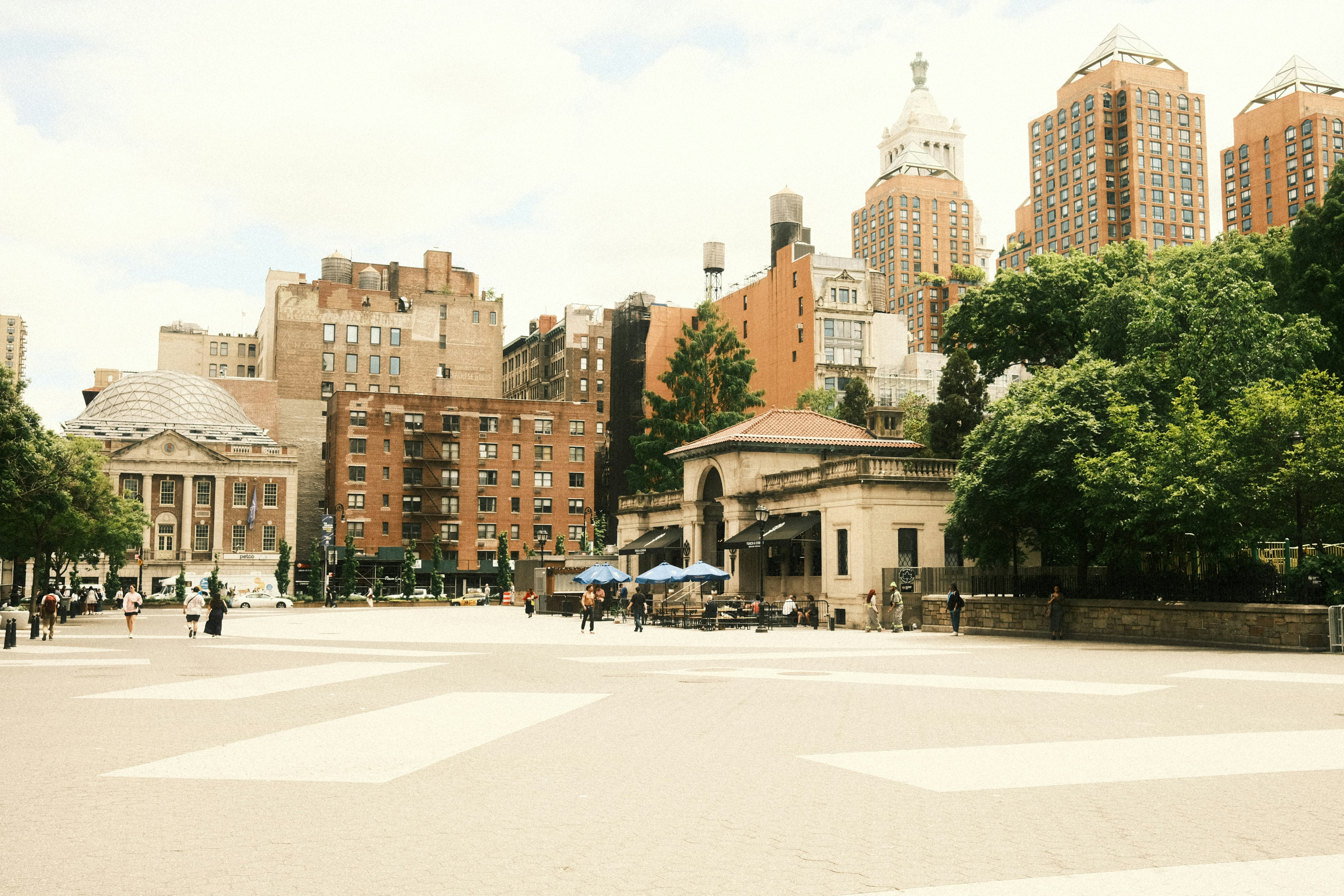 A group of people walking around a city square photo – Free City Image ...
