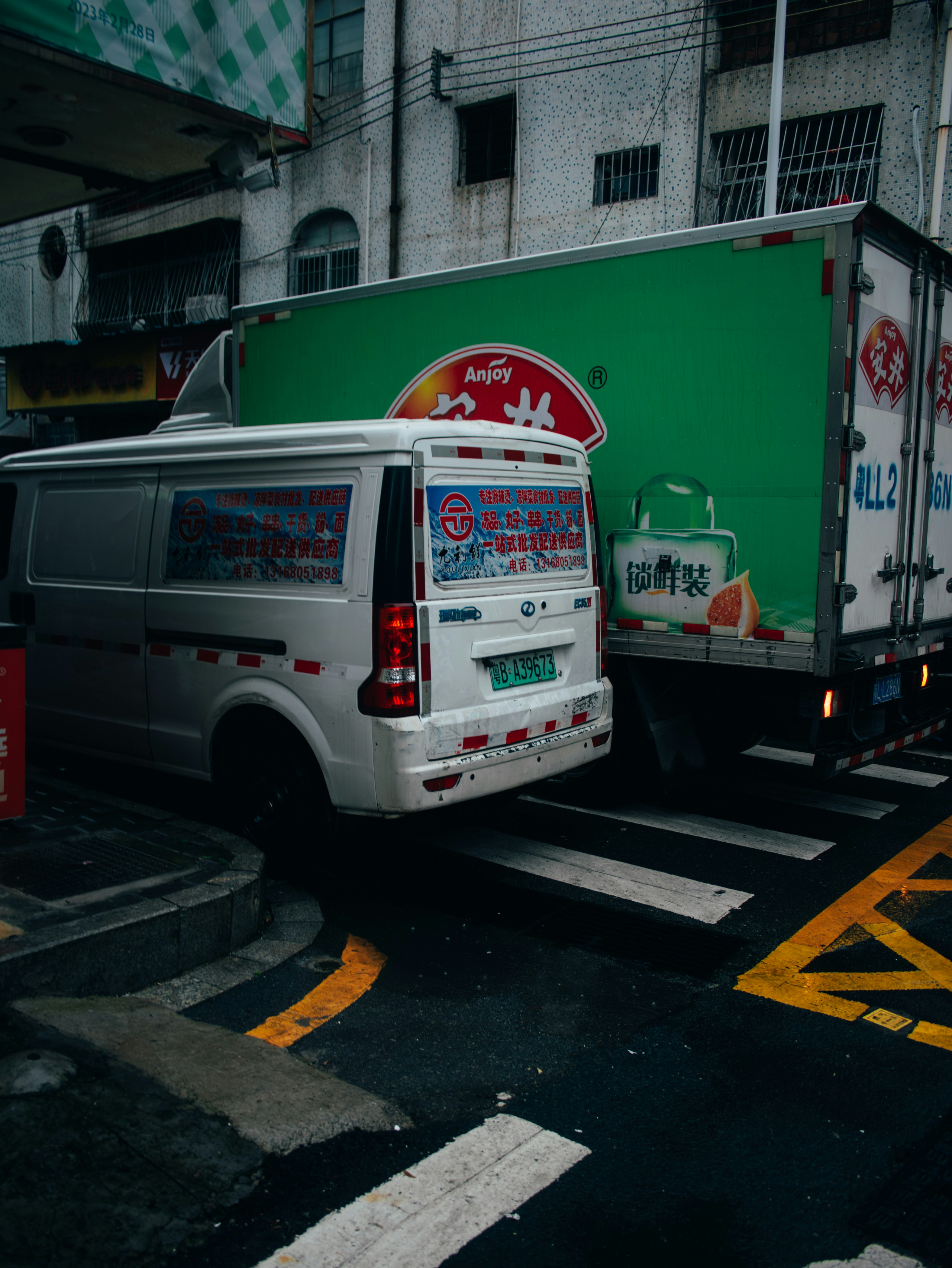 A white van is parked next to a green box truck photo – Free Shenzhen ...