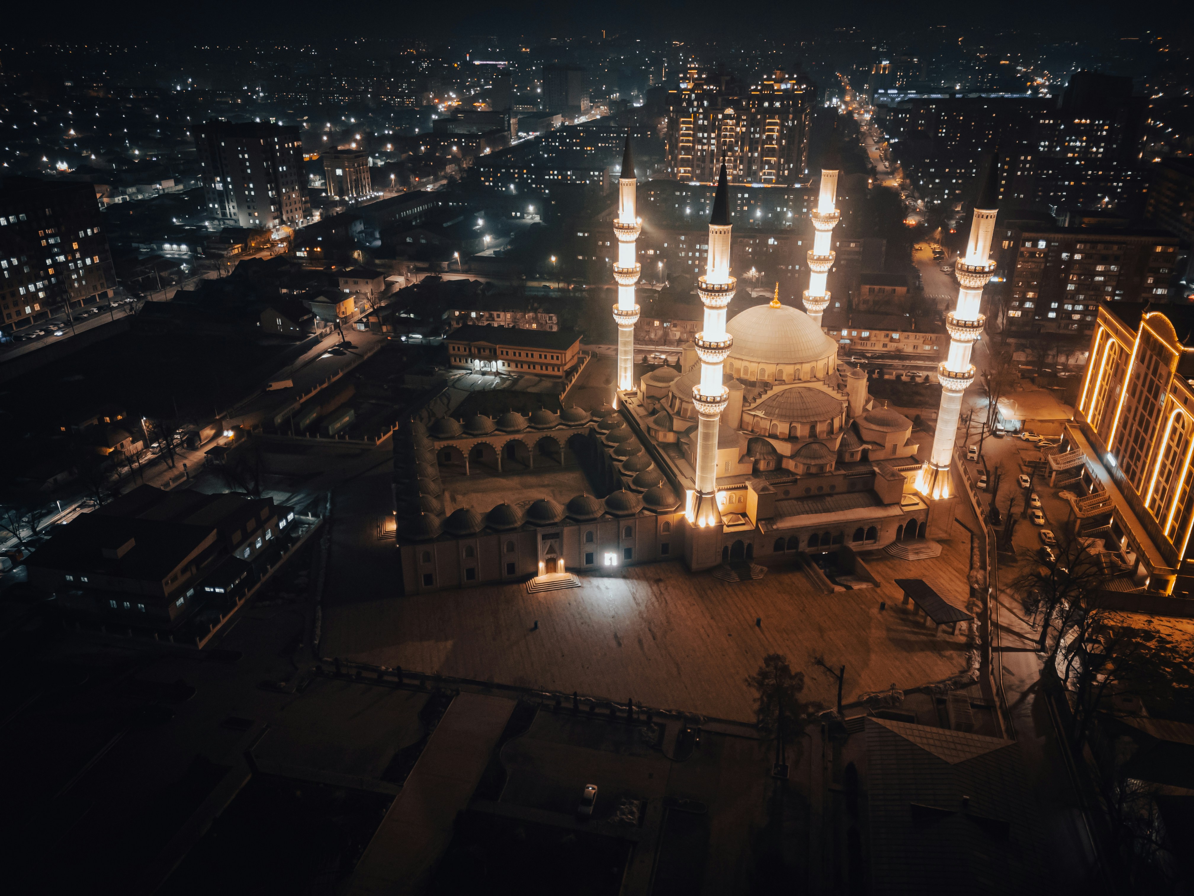 Night view of the illuminated Mosque with surrounding city lights