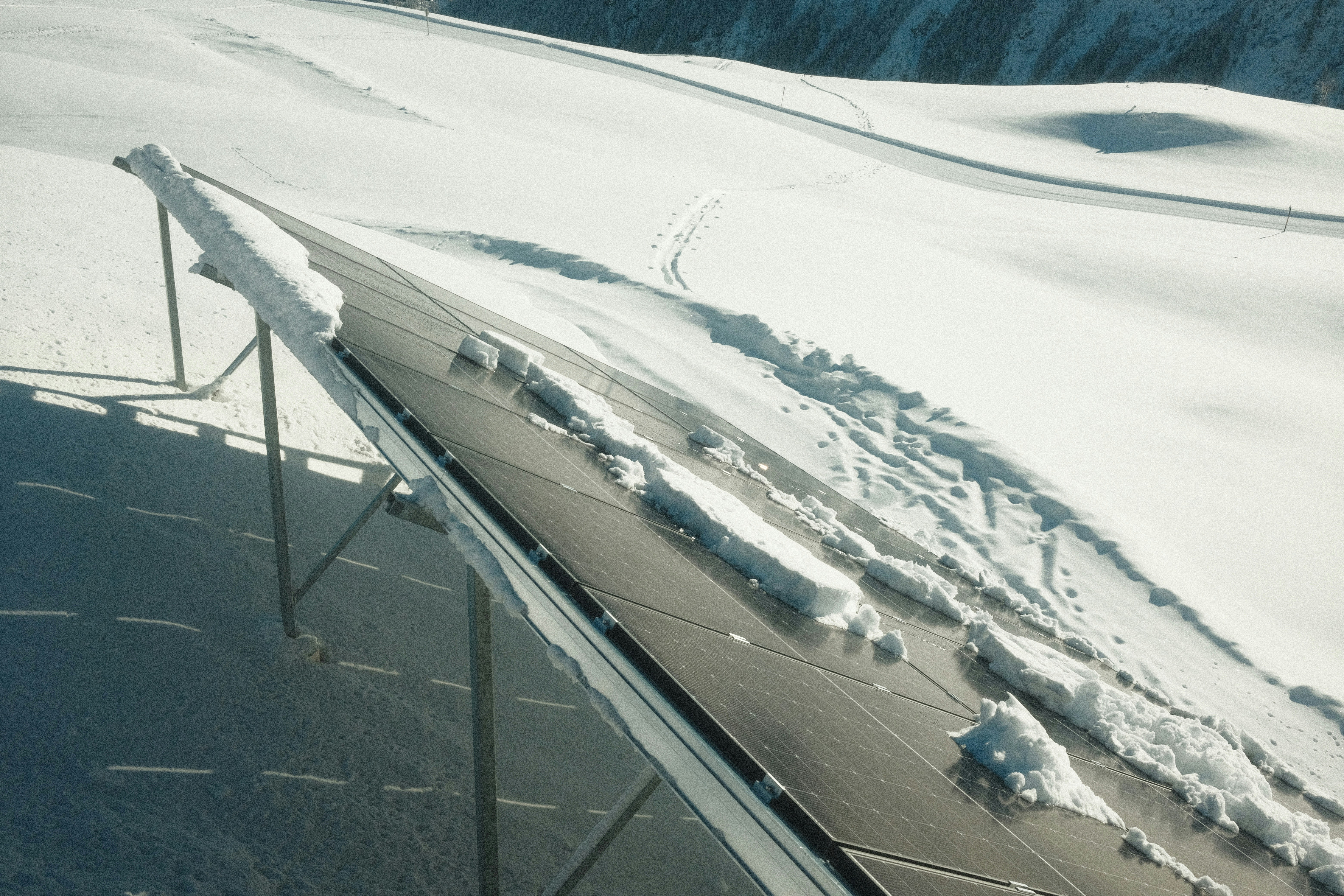 Snow-Capped Slope Traces a Ribbon of Solar Panels