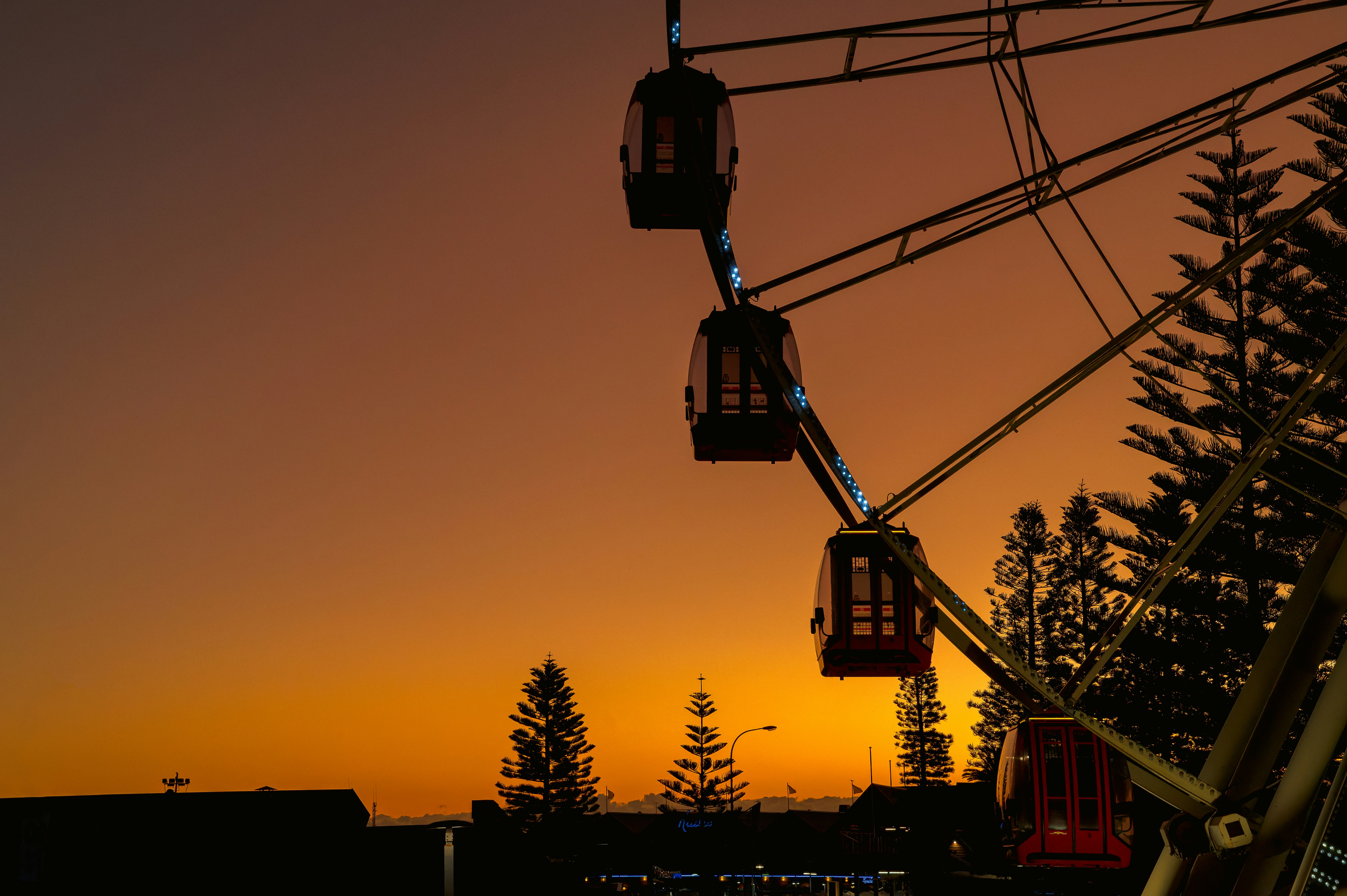 Dusk Over the Cableway: A Ferris Wheel’s Quiet Orange Moment