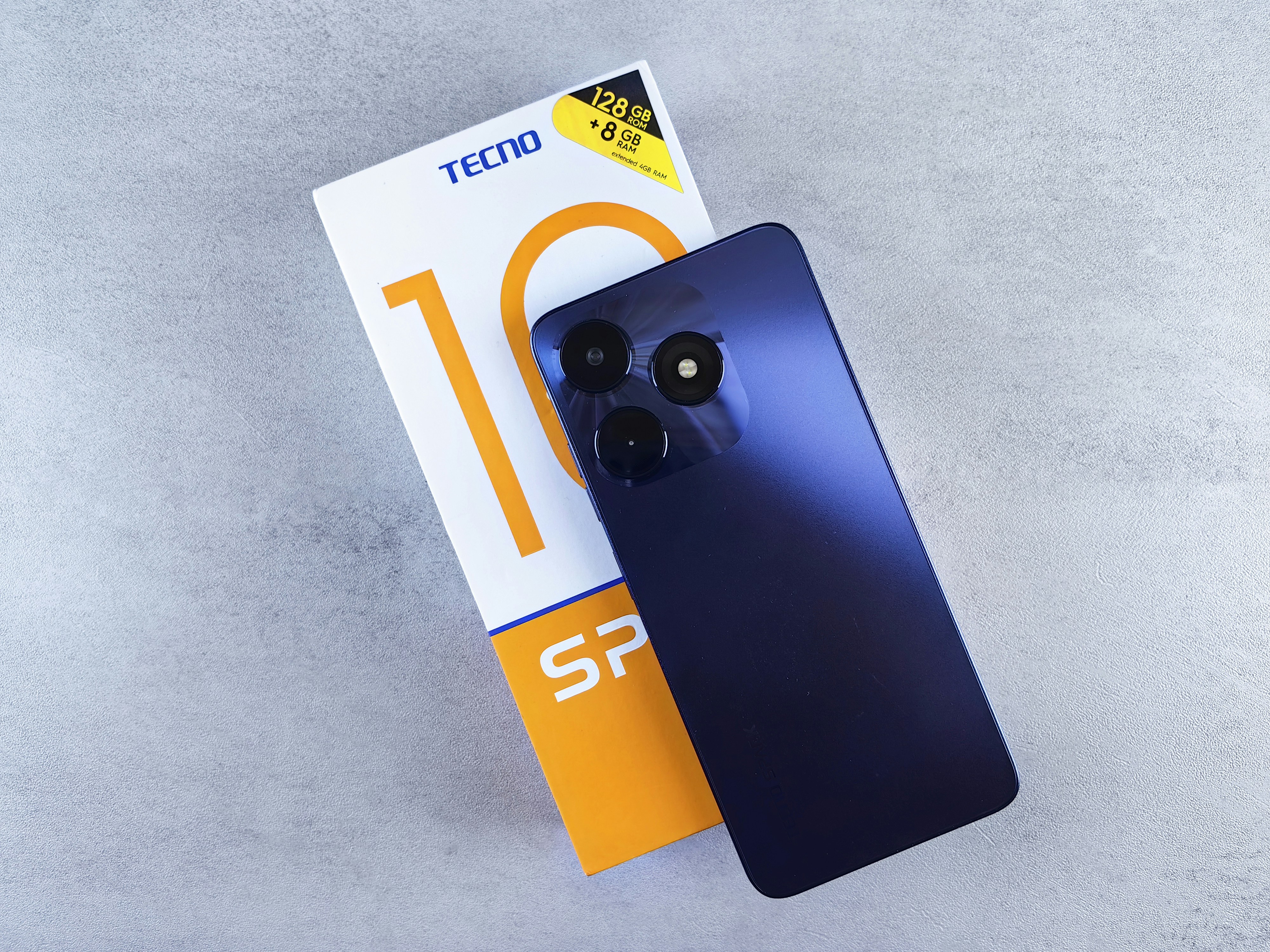 A blue cell phone sitting on top of a box photo – Free Camera Image on ...