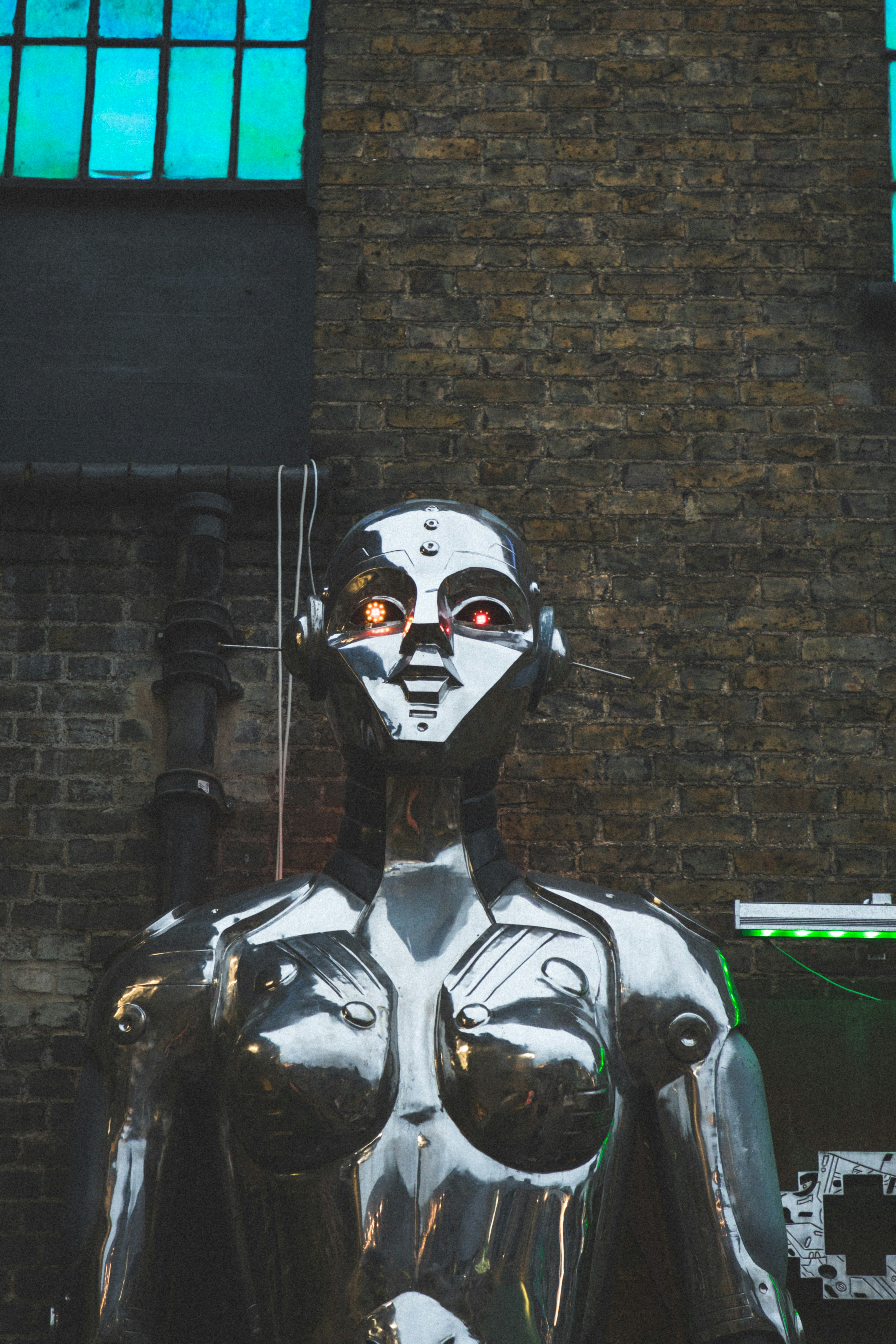 a statue of a woman in front of a brick building