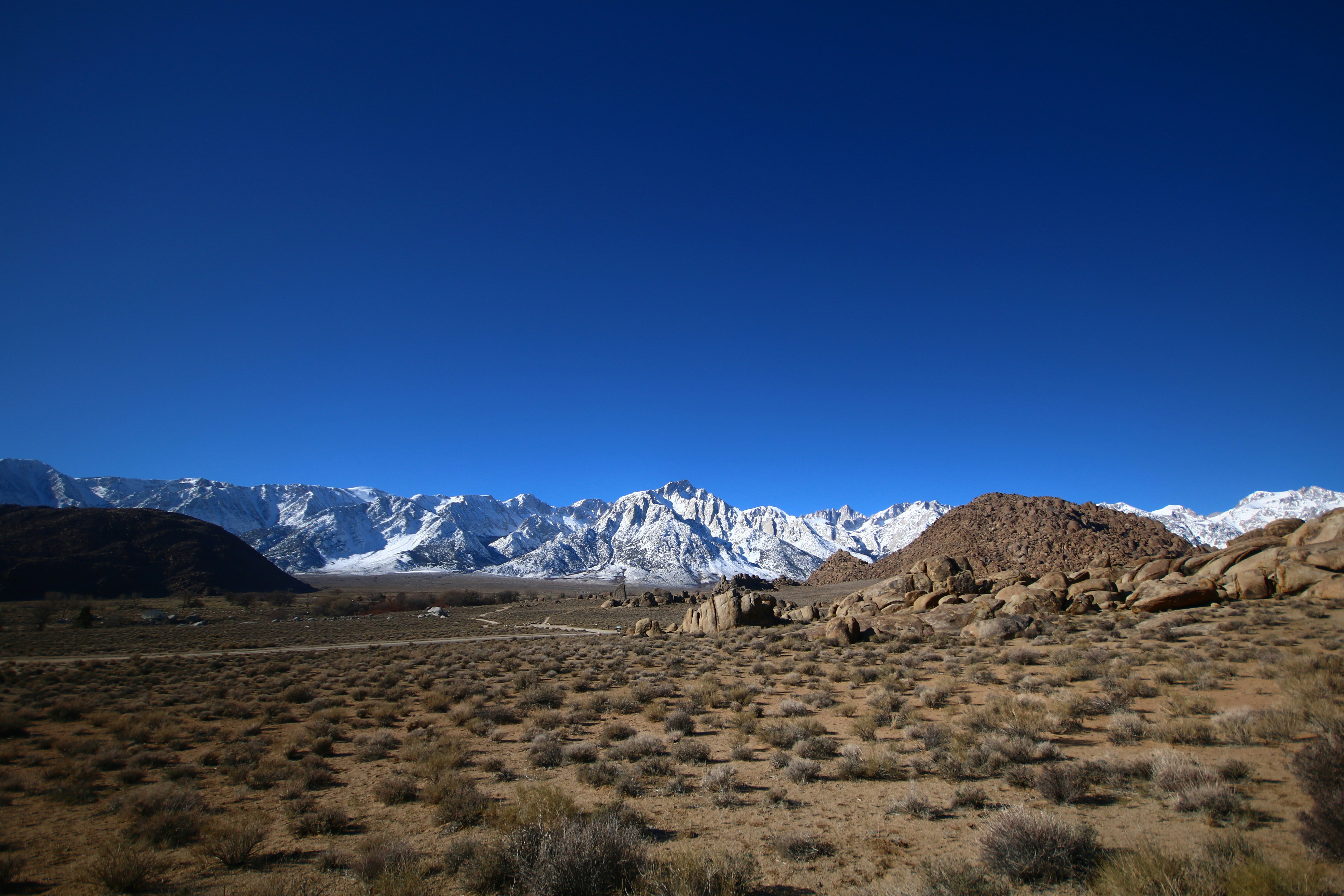 Ivory Peaks Above a Desert Mosaic Under a Sapphire Sky