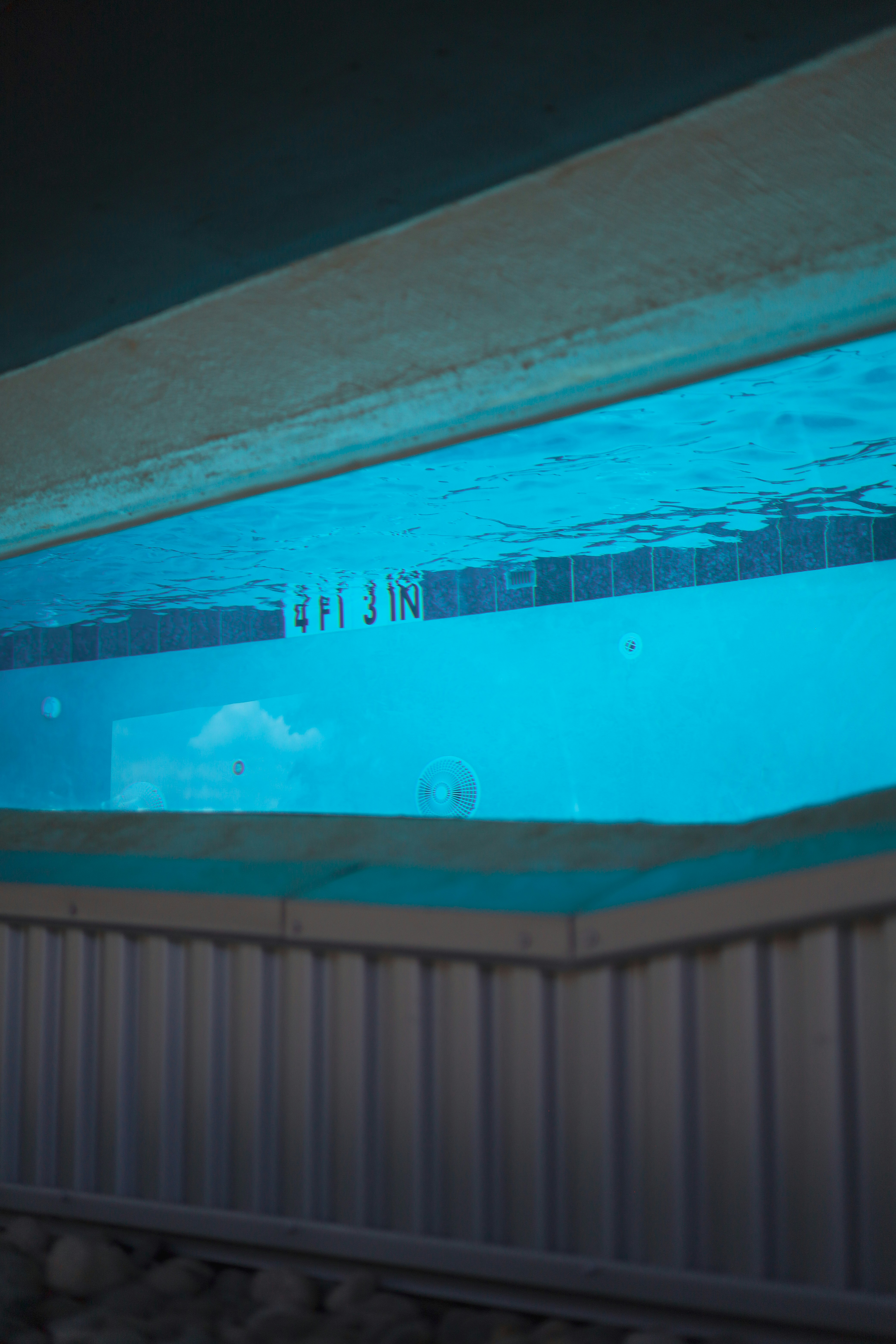 A swimming pool with a blue light reflecting off of the water photo ...
