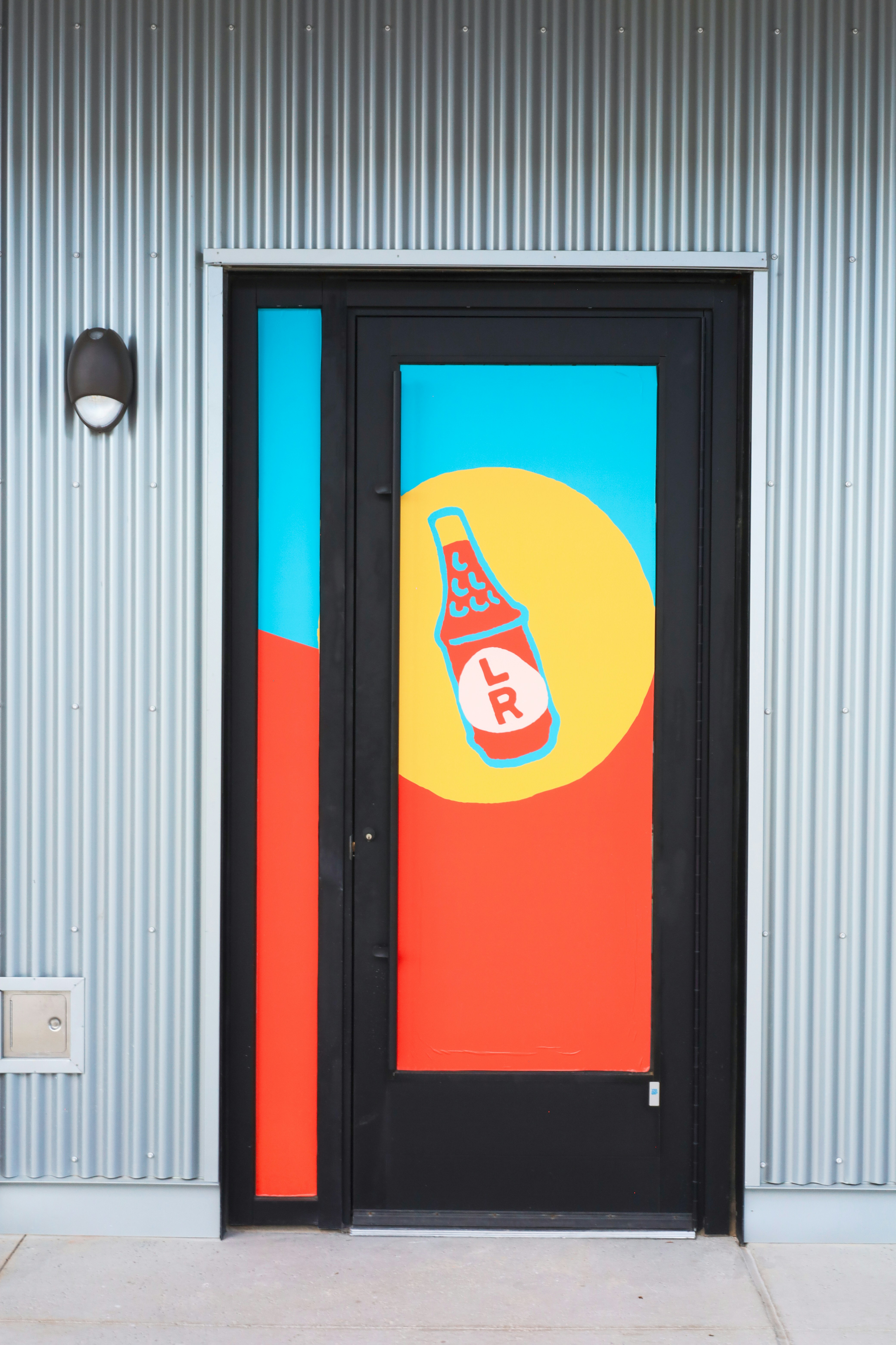 a door with a painting of a bottle on it
