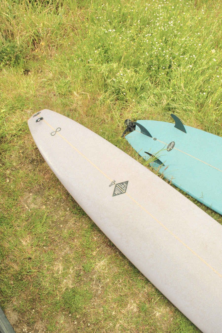 Two surfboards | two surfboards laying on the ground in the grass