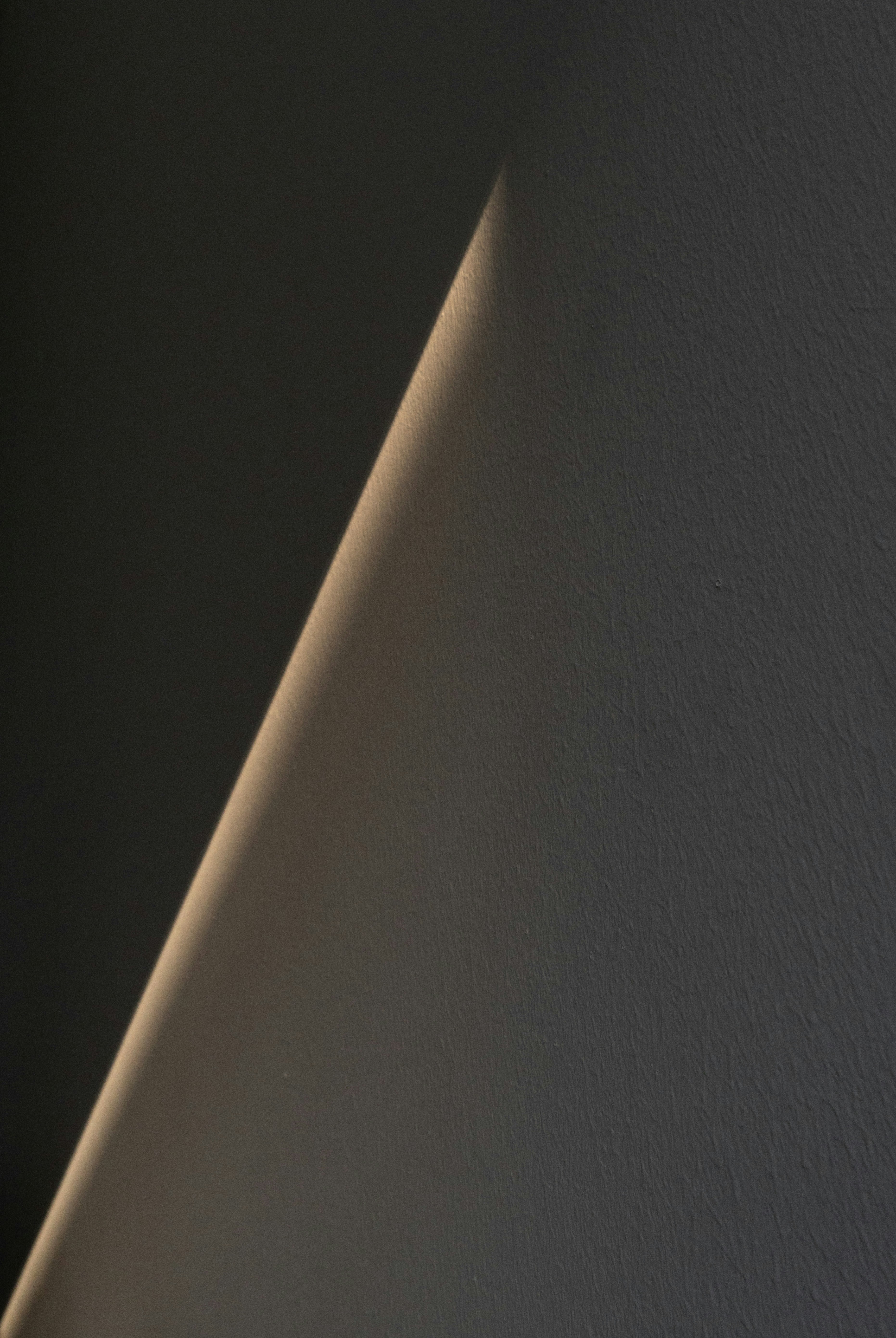 Sliver of Dawn: Light Divides a Quiet Wall