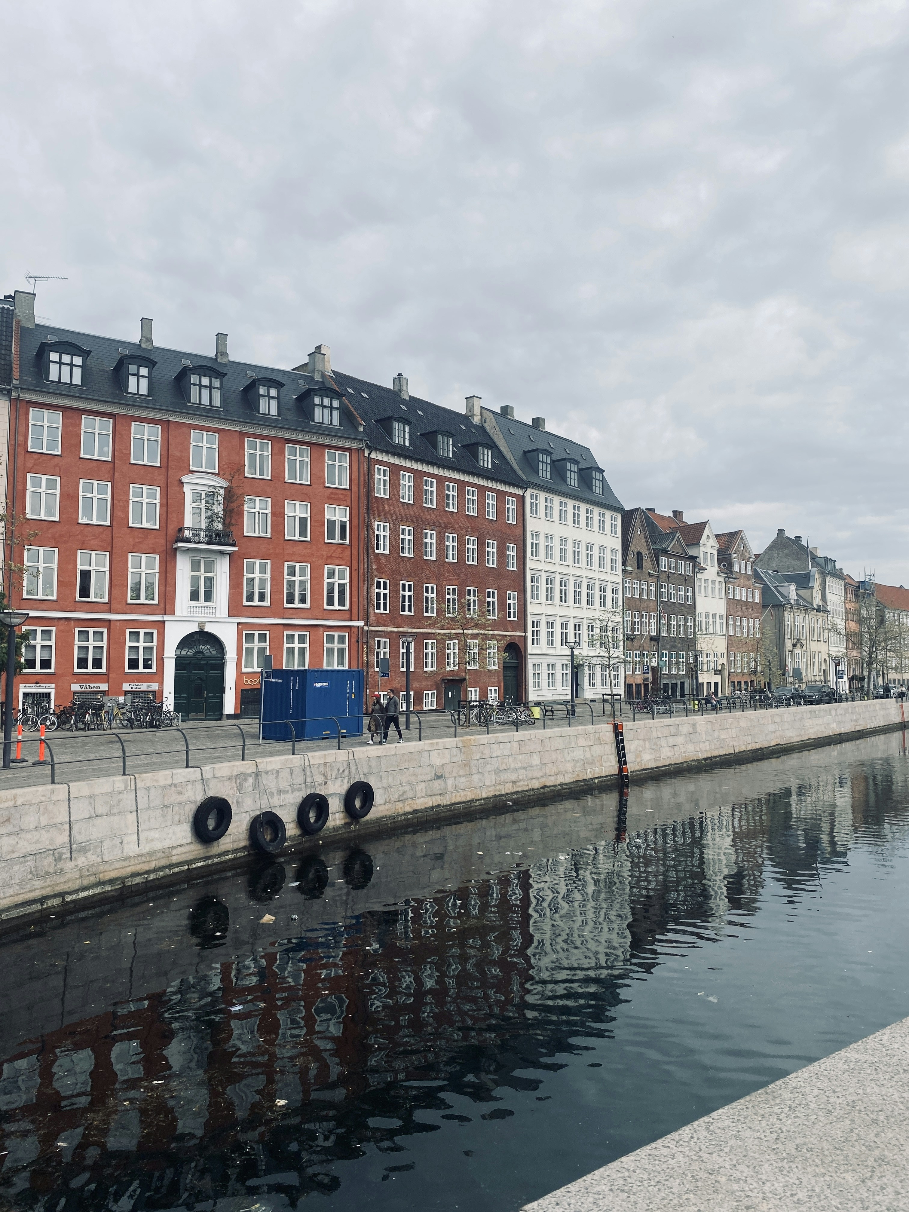Pastel Canal Row: Brick Facades Reflected Under a Cloudy Sky