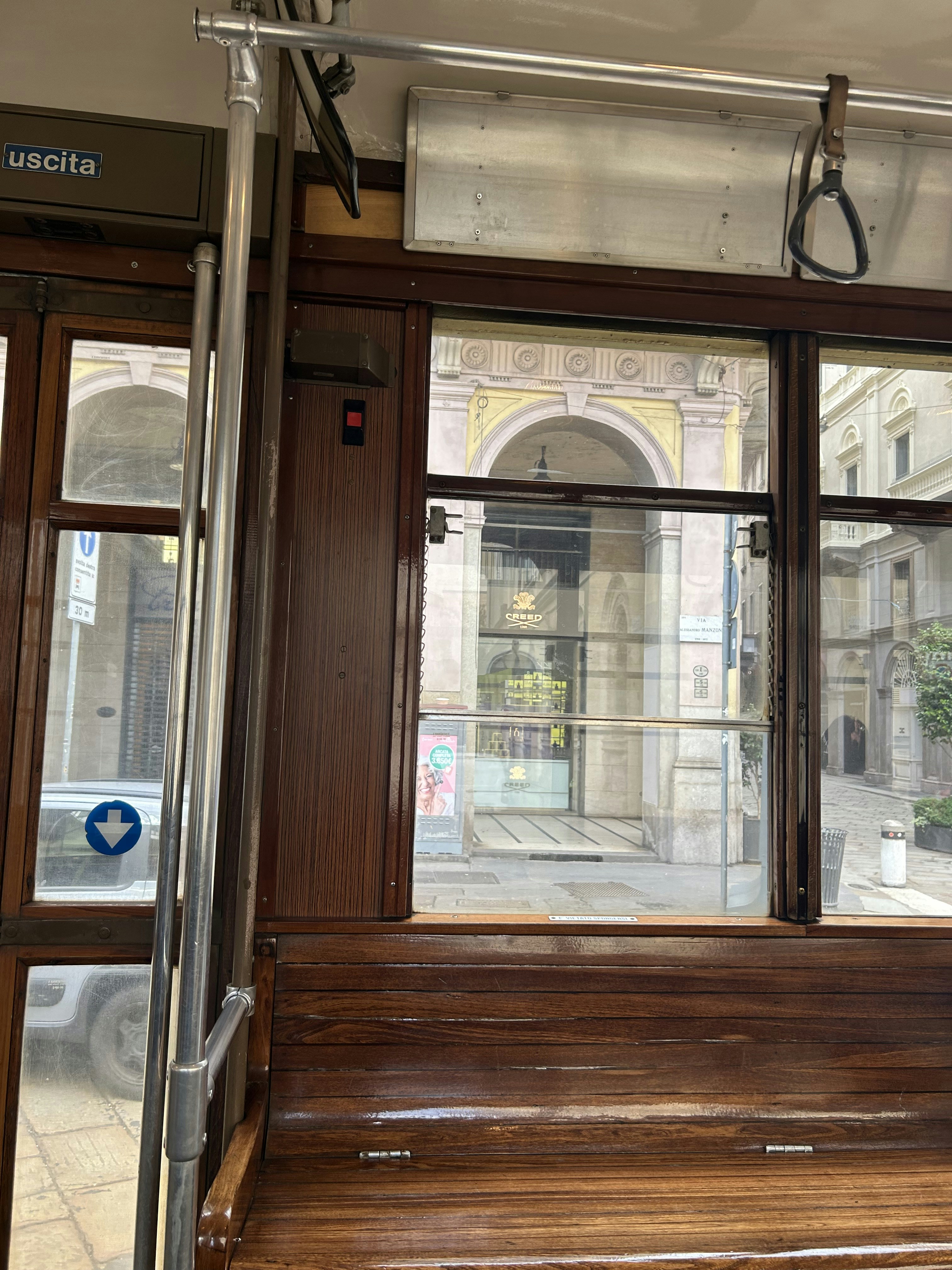 Archway in Focus: City Facade Framed by a Wooden Tram Window