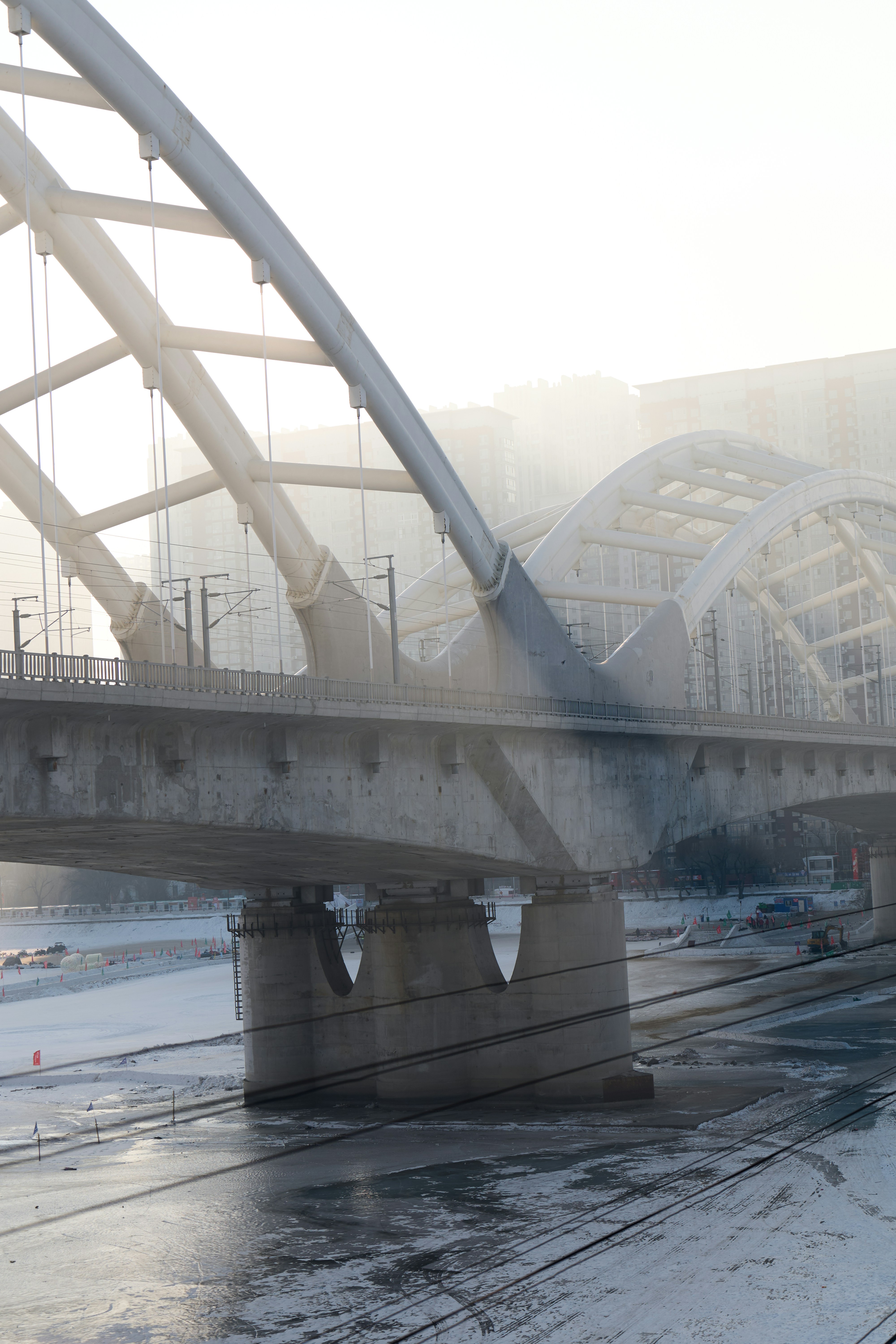 Snowy Riverwalk Arch: A Quiet Moment Under the Bridge