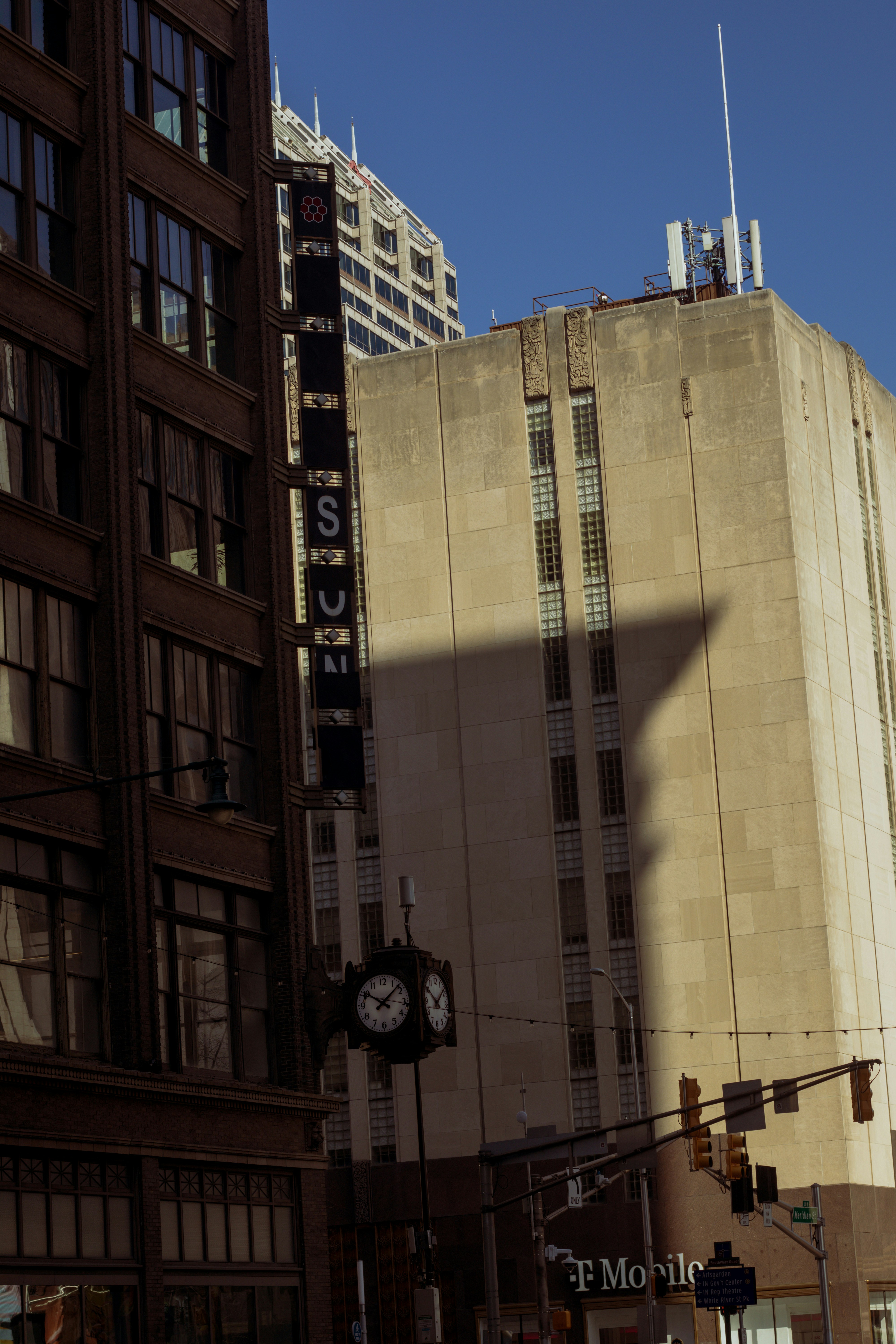 A tall building with a clock on the side of it photo – Free City Image ...
