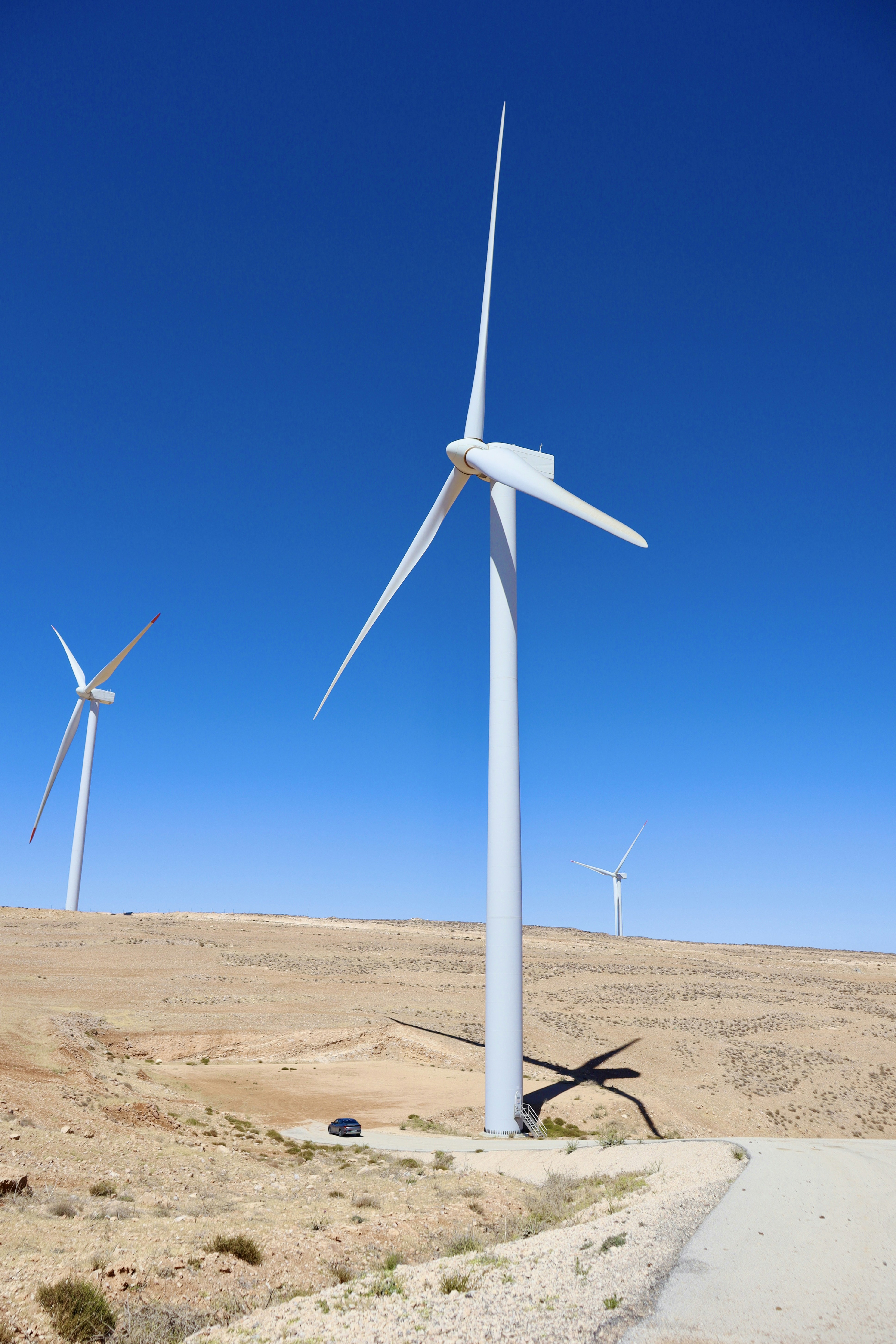 A group of wind turbines in the desert photo – Free Renewable energy ...