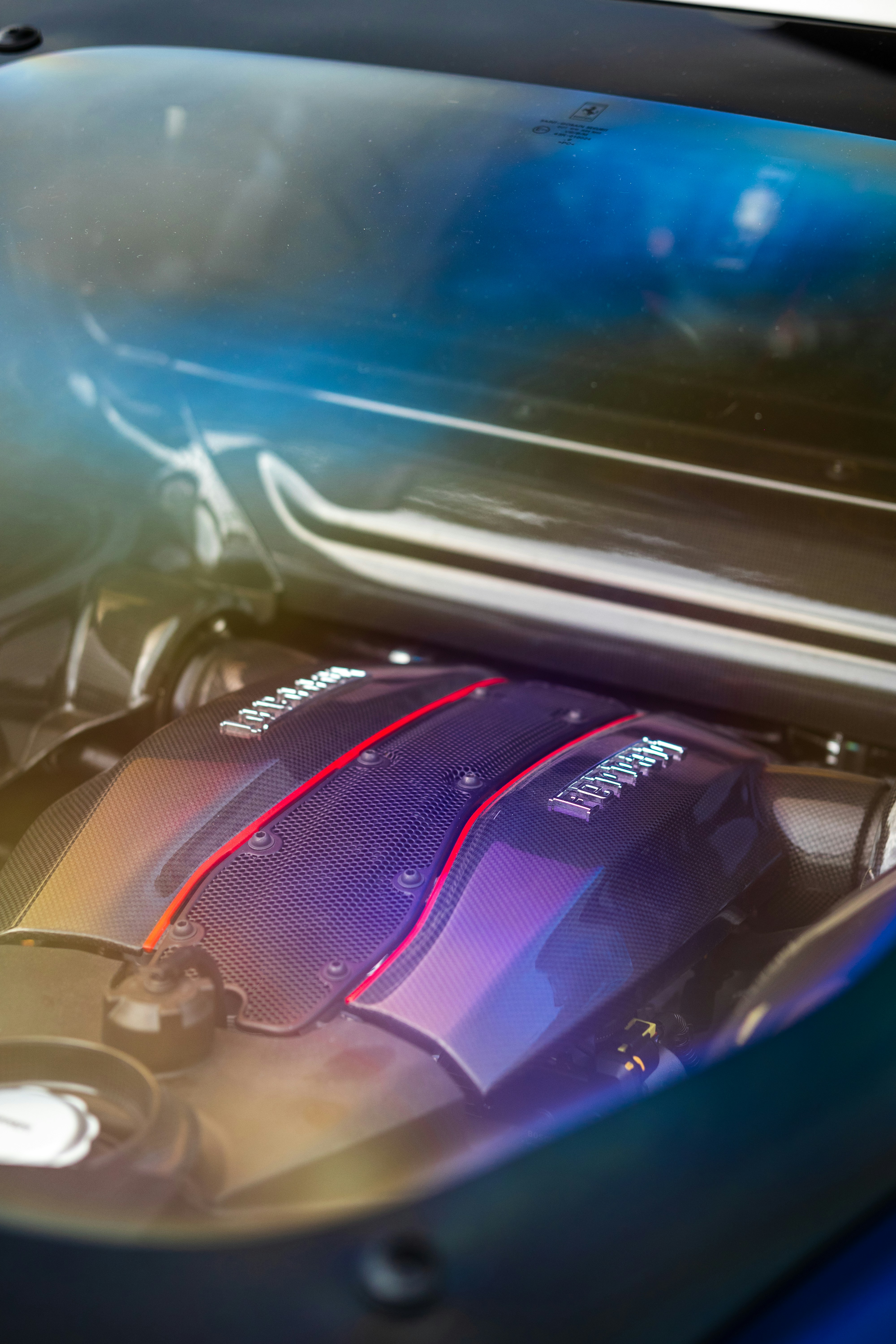 The engine compartment of a blue car with a red stripe photo – Free 488 ...