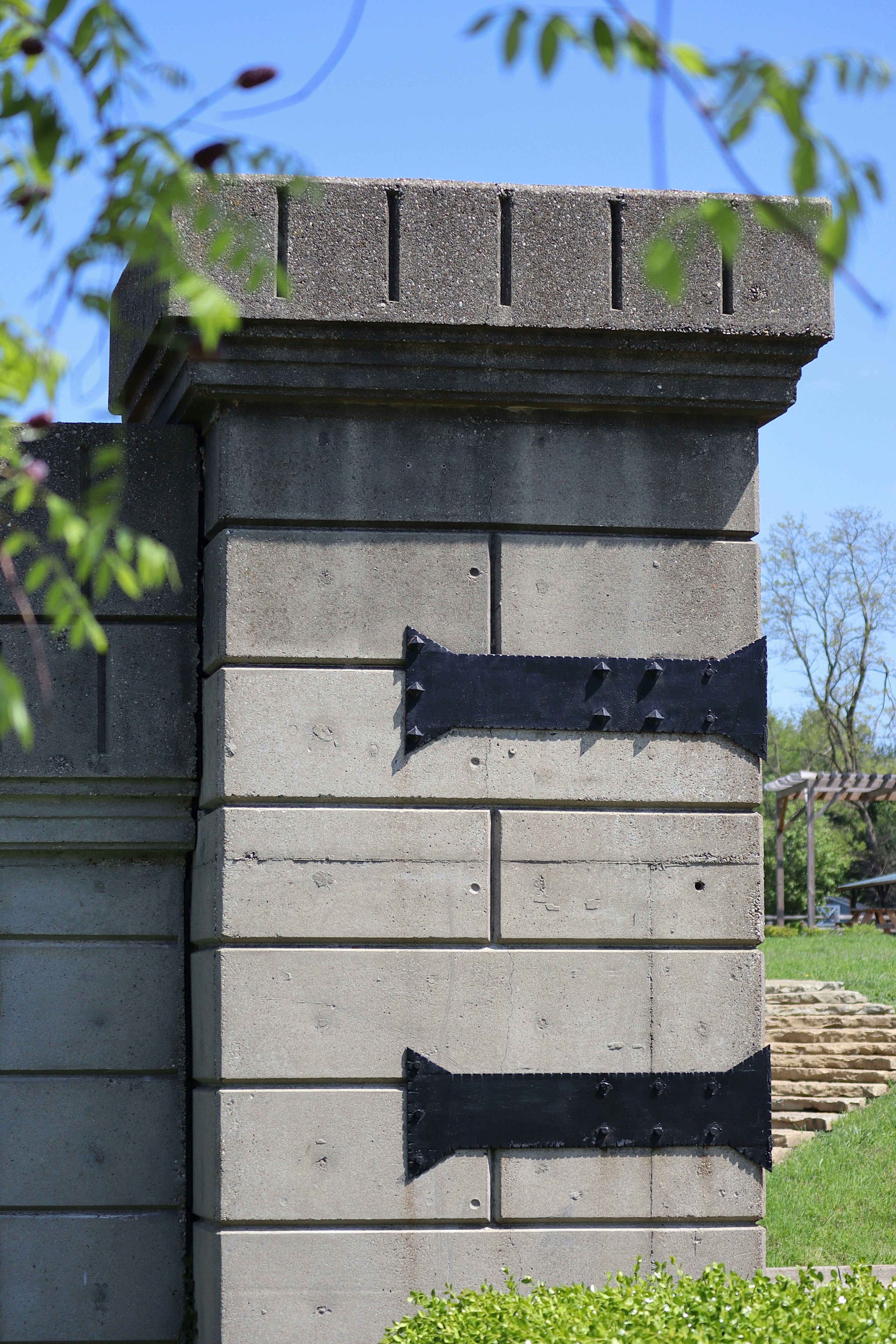 Iron-Strapped Pillar in Sunlit Stone Architecture