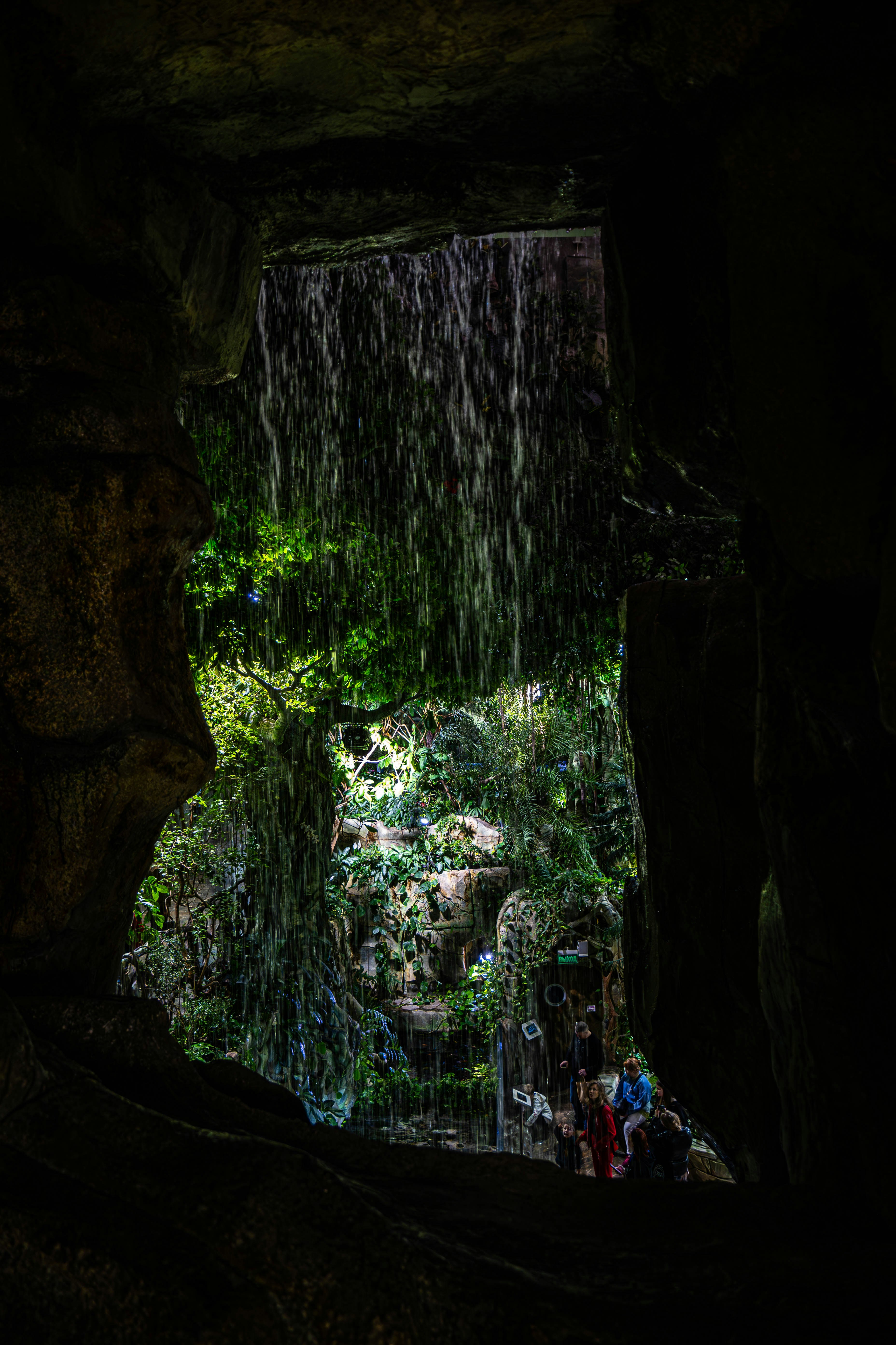 a group of people standing under a waterfall