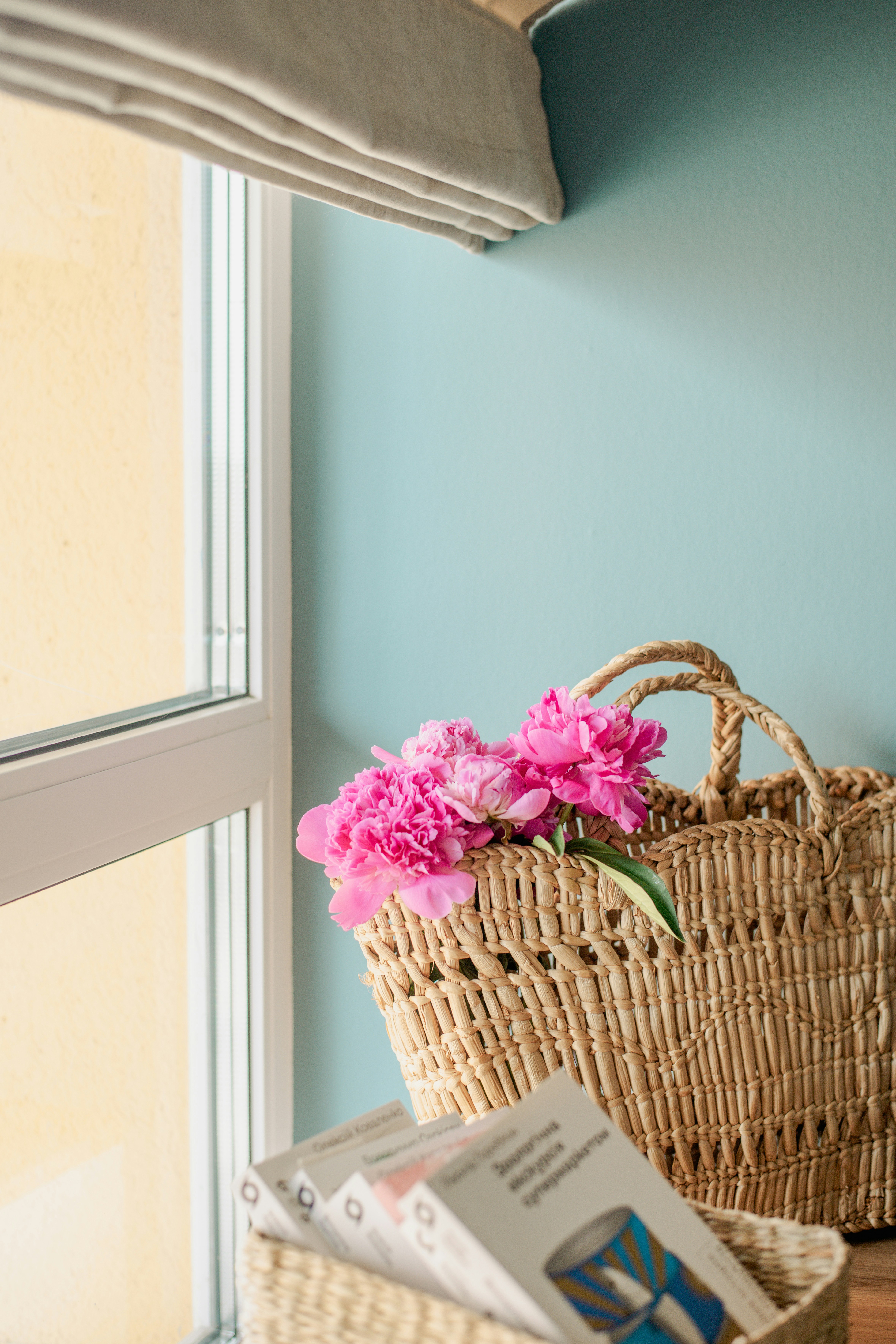 A wicker basket with pink flowers on a window sill photo – Free Window ...