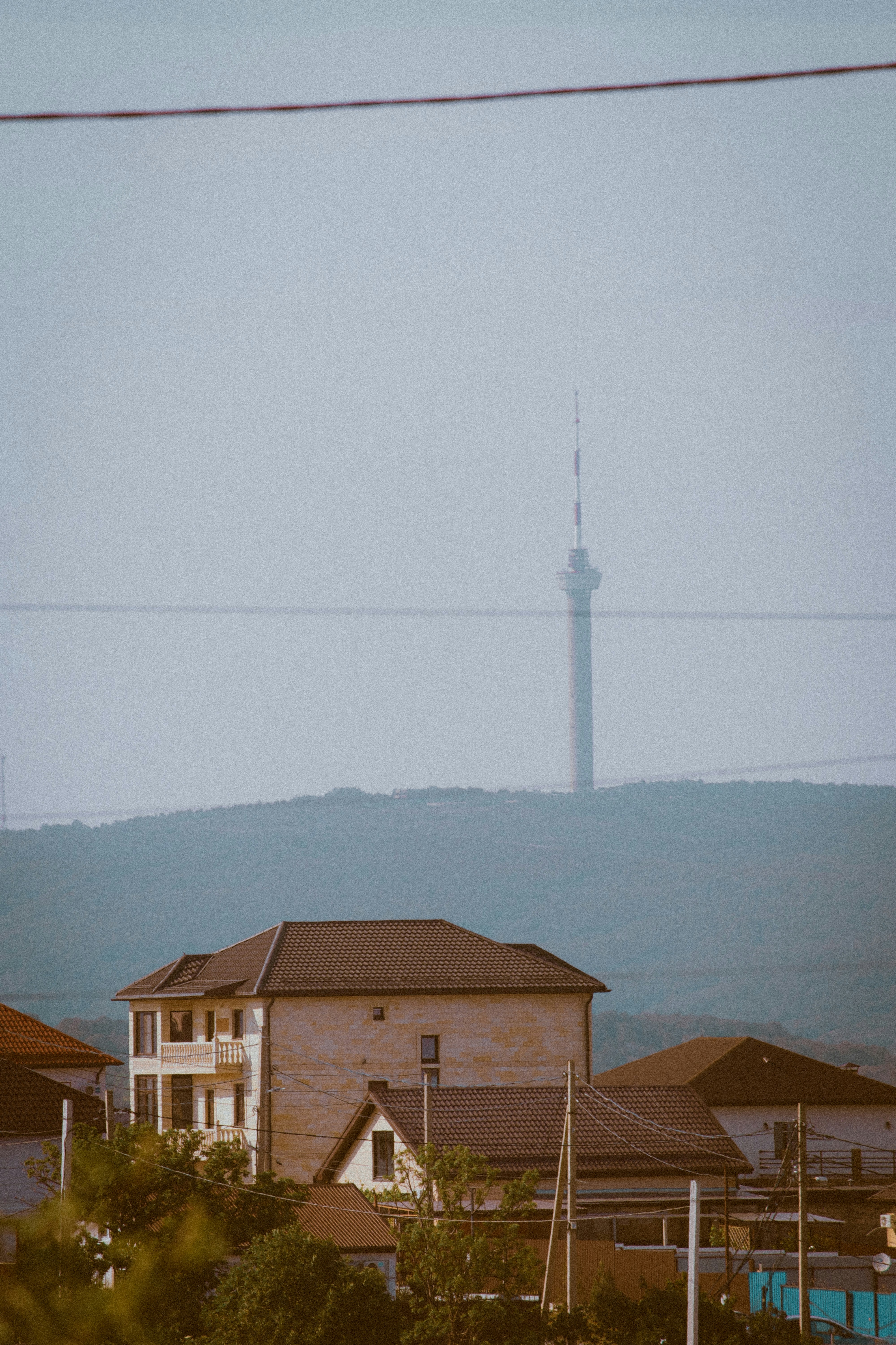 Mast over the Misty Ridge: Suburban Quiet Beneath a Distant Signal