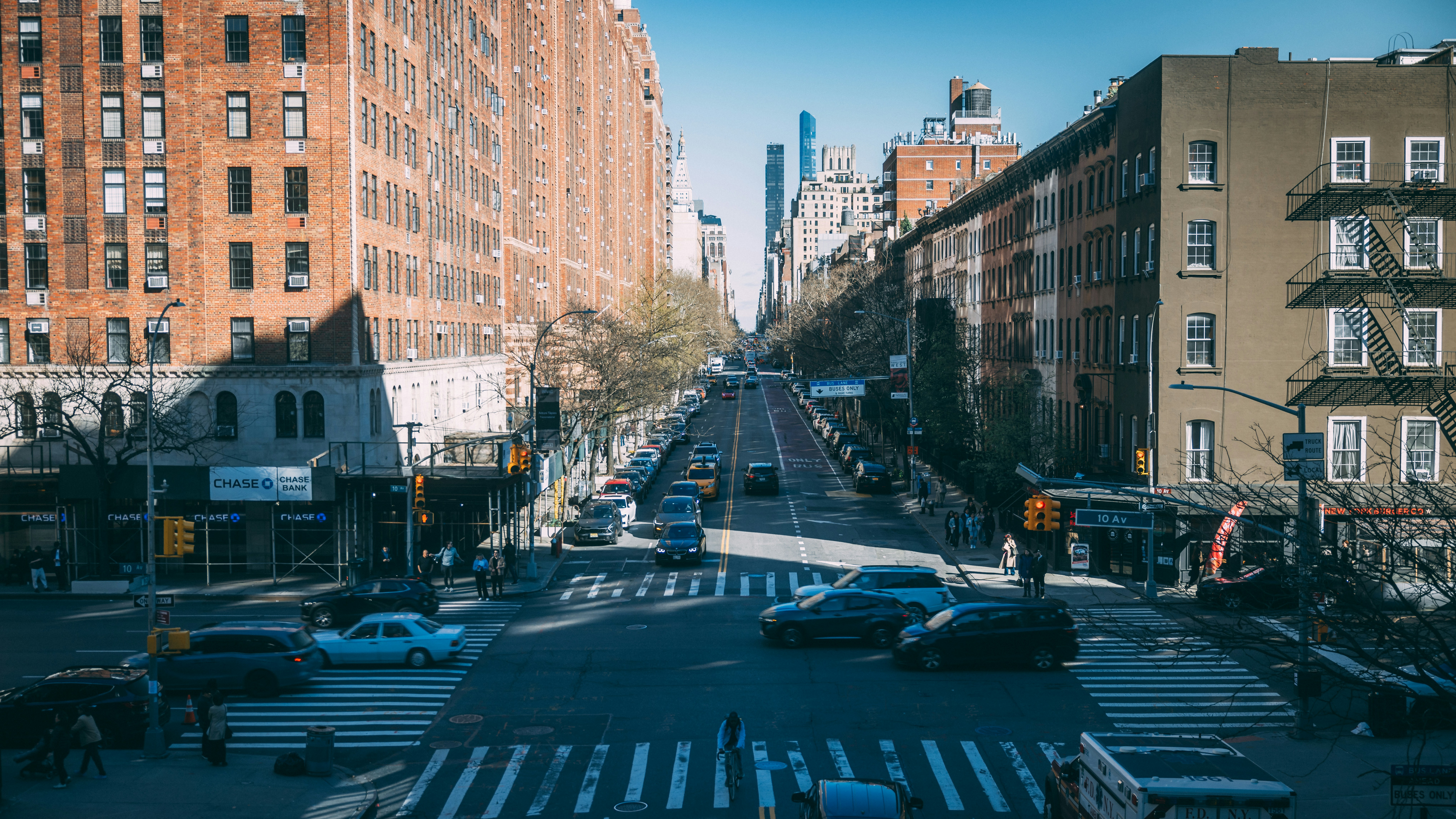 A city street filled with traffic next to tall buildings photo – Free ...