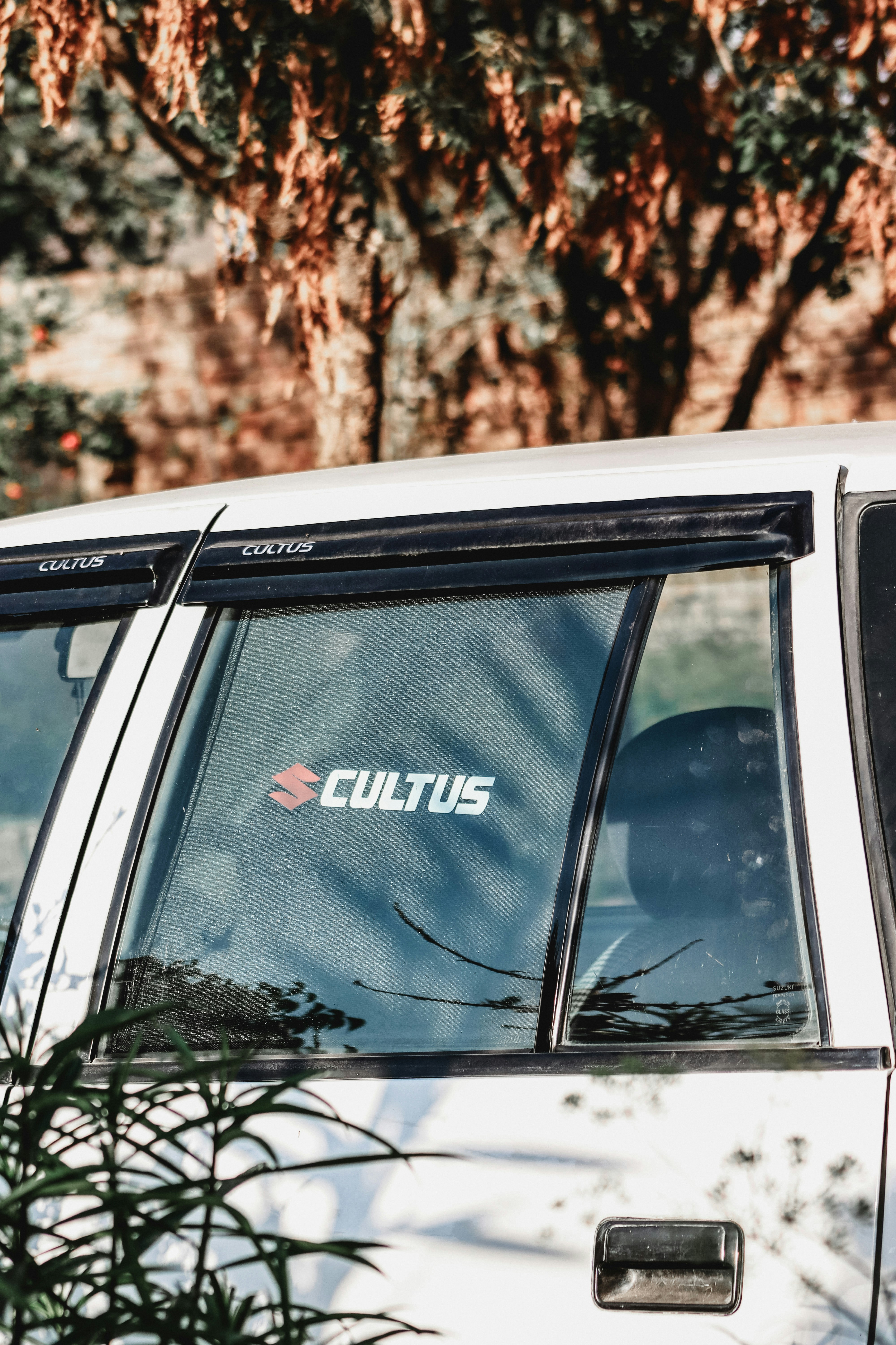 CULTUS Emblem Glint on a Sunlit SUV Window
