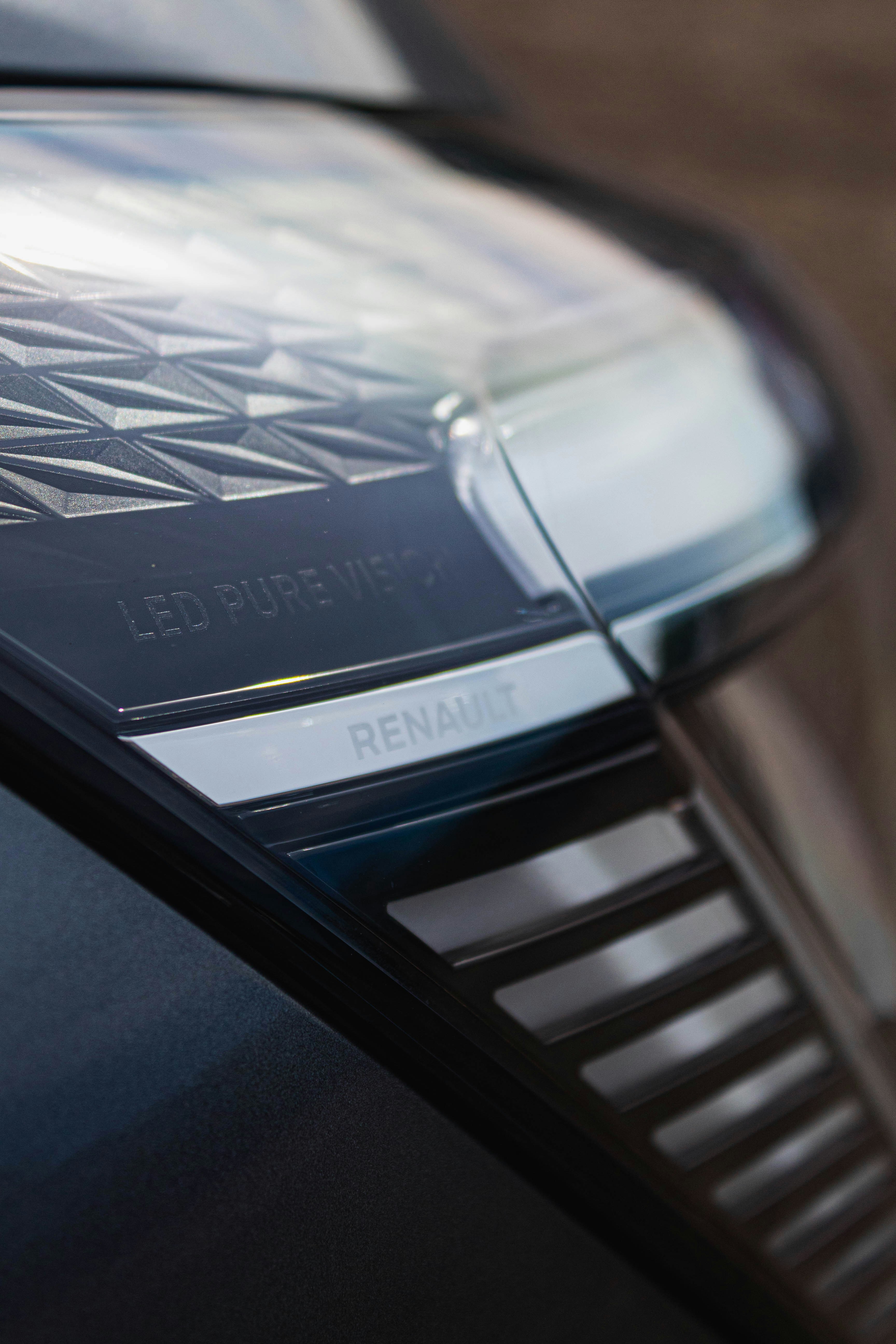 Precision in Chrome: The Renault Badge Jut Under a Geometric Hood
