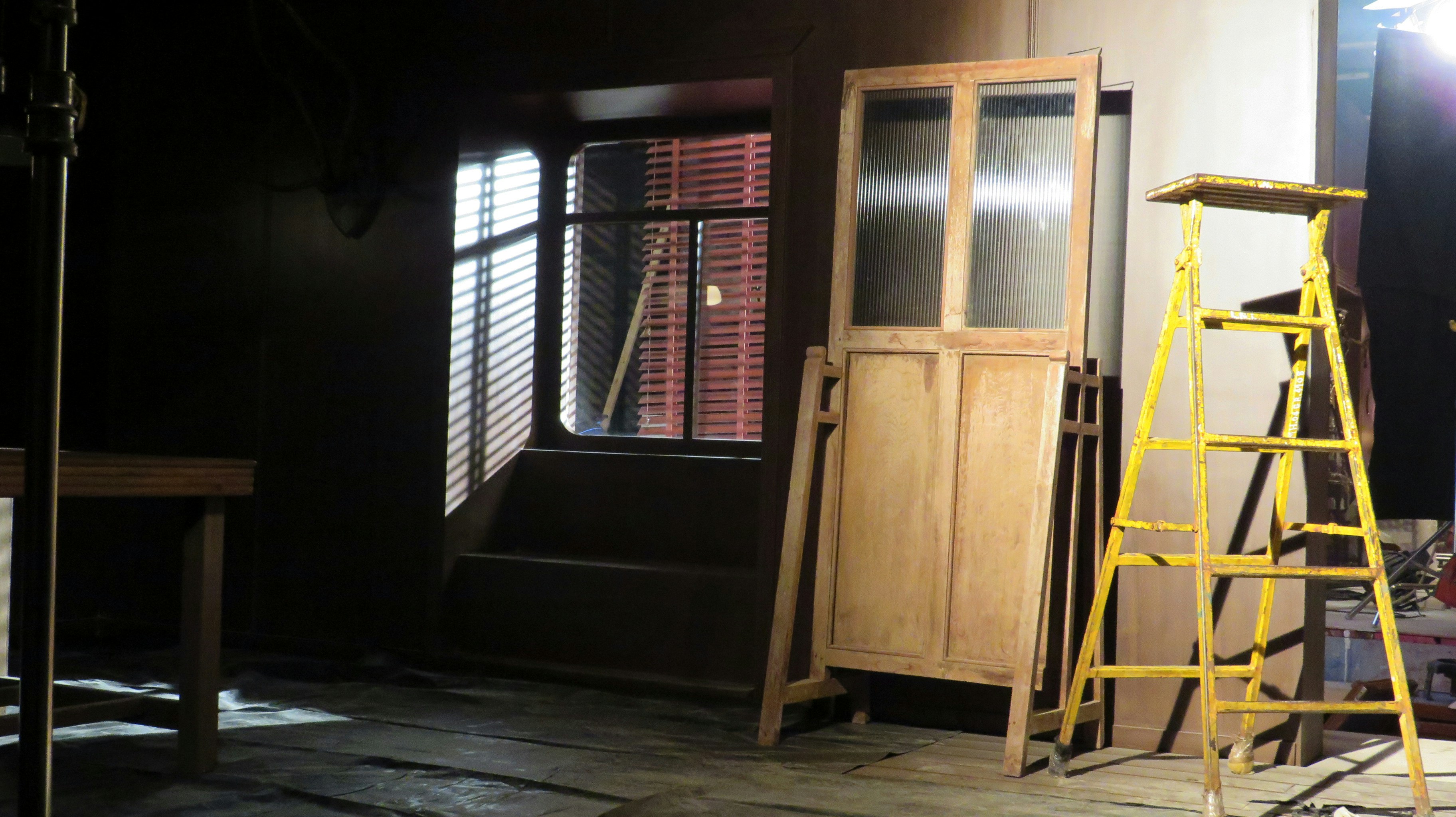 Yellow Ladder in a Dim Workshop: Light Pierces a Quiet Stage