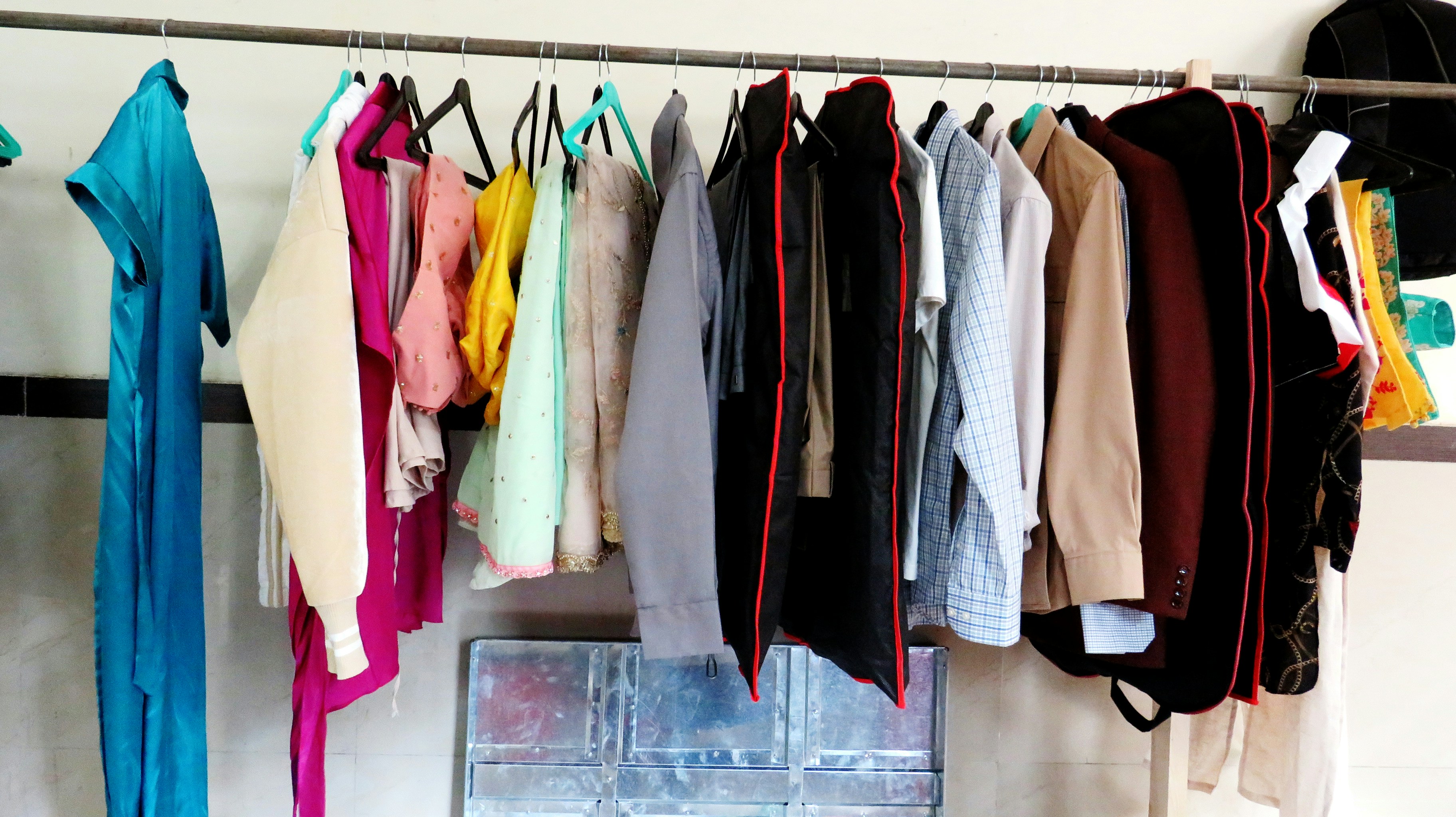 A bunch of clothes hanging on a clothes rack photo – Free Mumbai Image ...