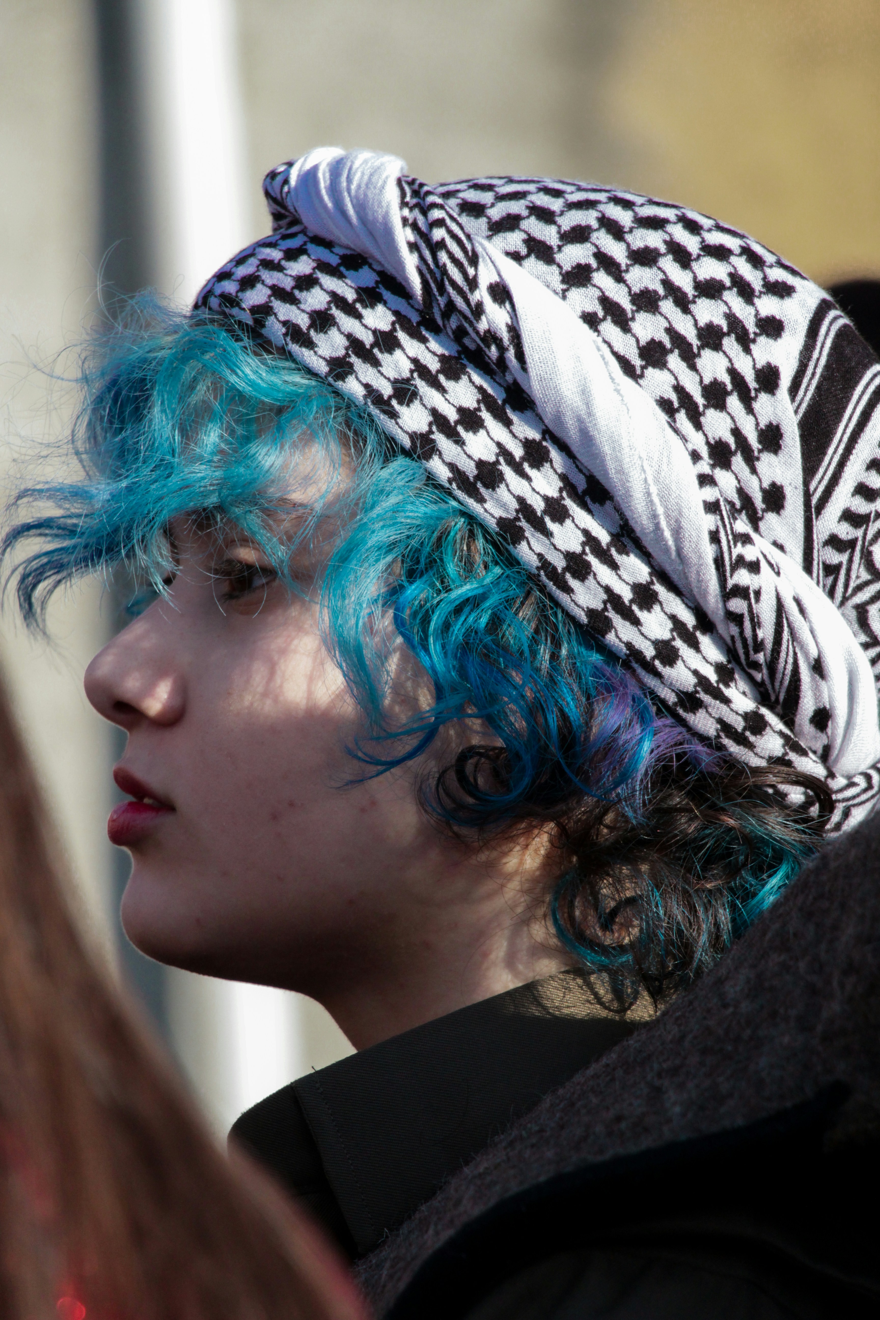 Turquoise Tresses under a Keffiyeh: A Portrait of Bold Color and Quiet Gaze