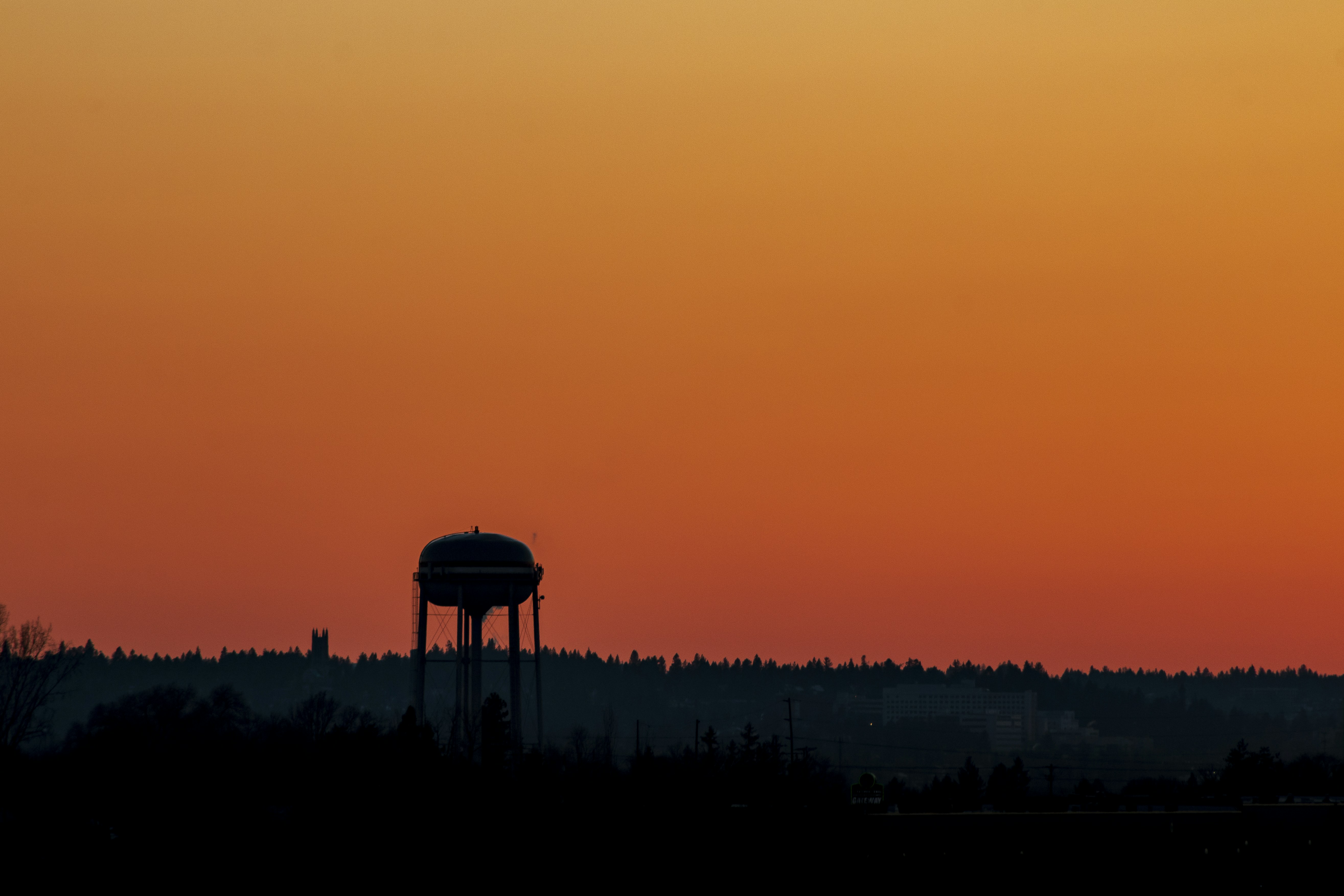 Ember Horizon: Silhouette of a Water Tower at Dusk