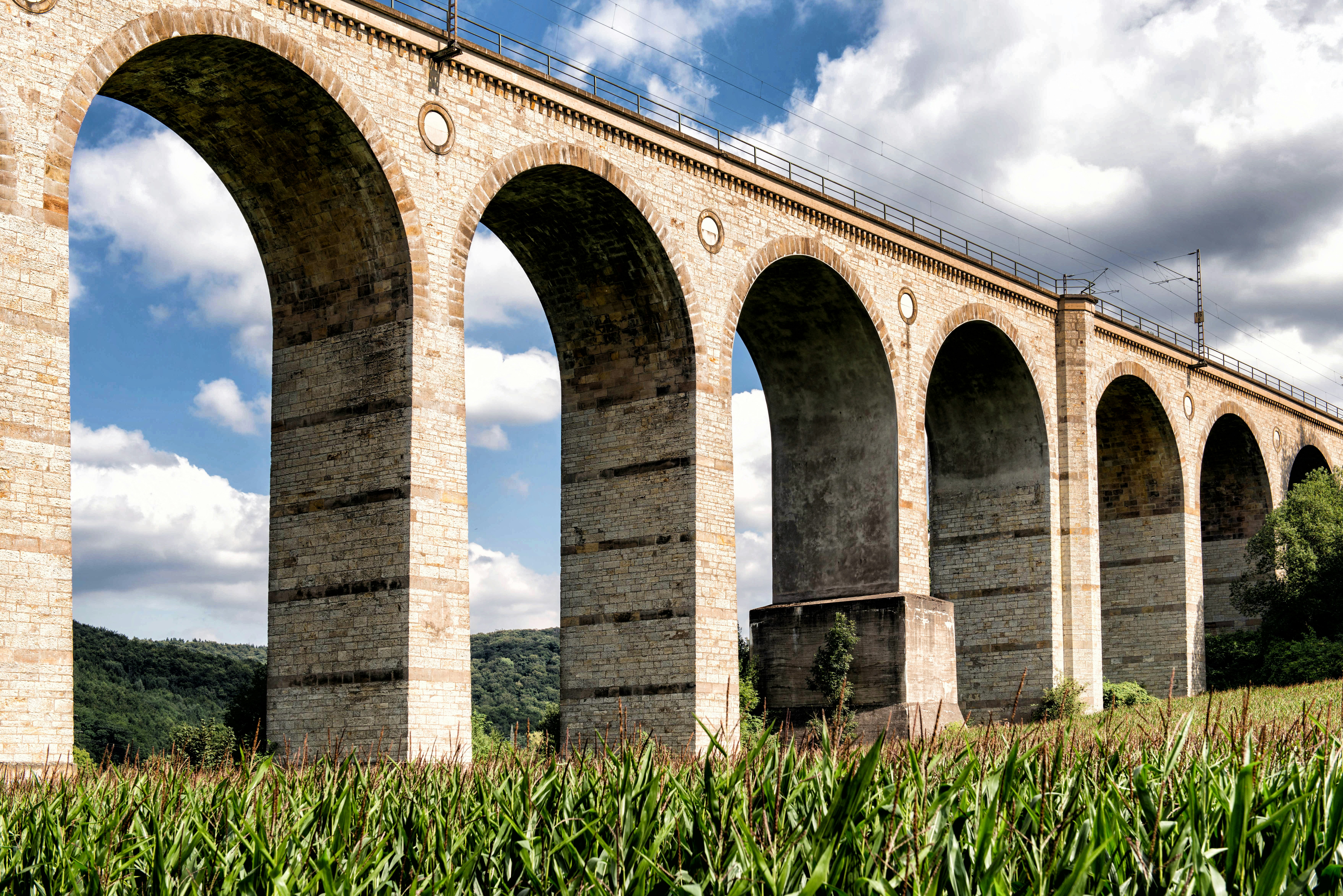 A large stone bridge over a lush green field photo – Free Altenbeken ...