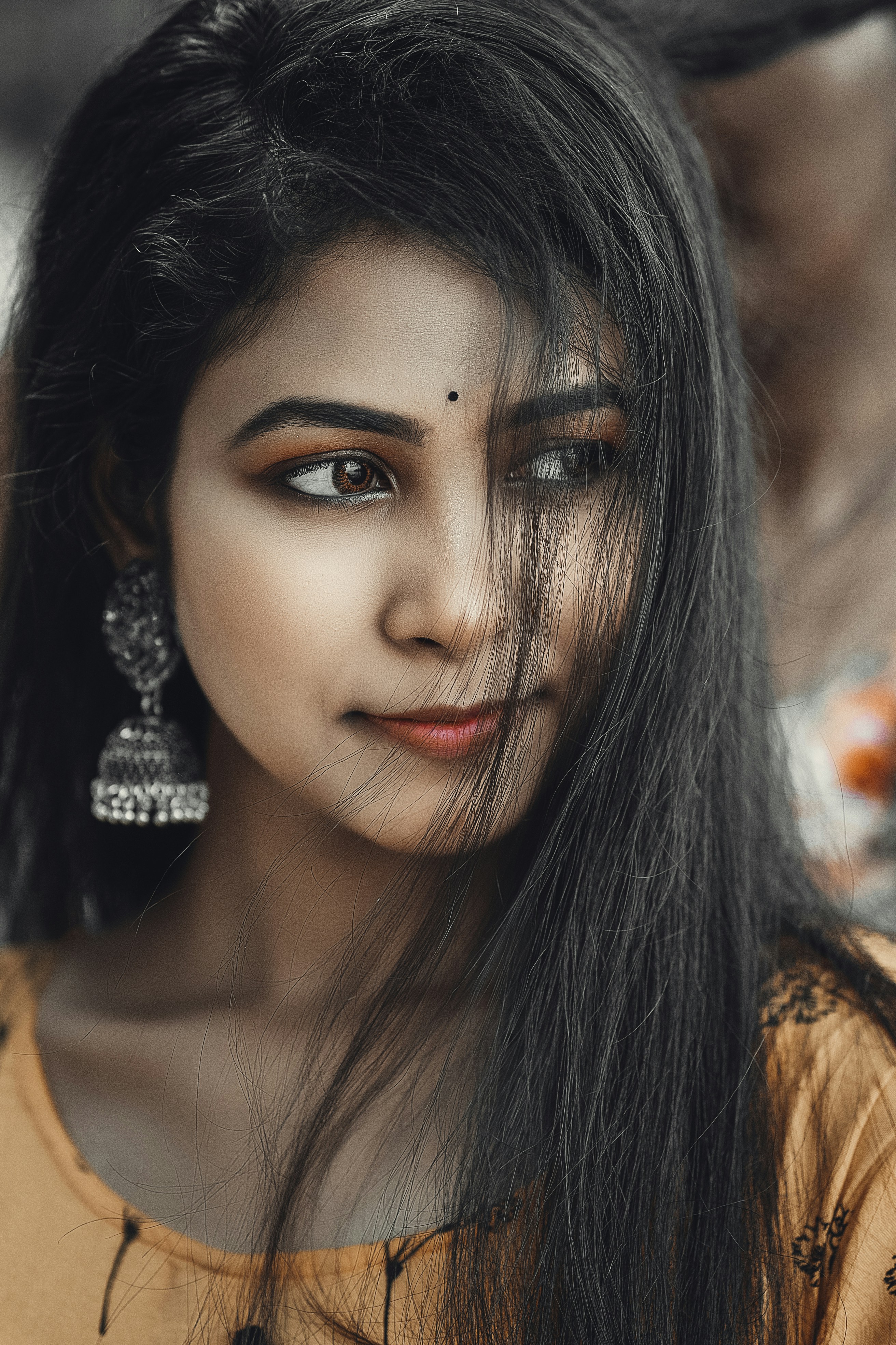 A woman with long black hair and earrings photo – Free Woman Image on Unsplash