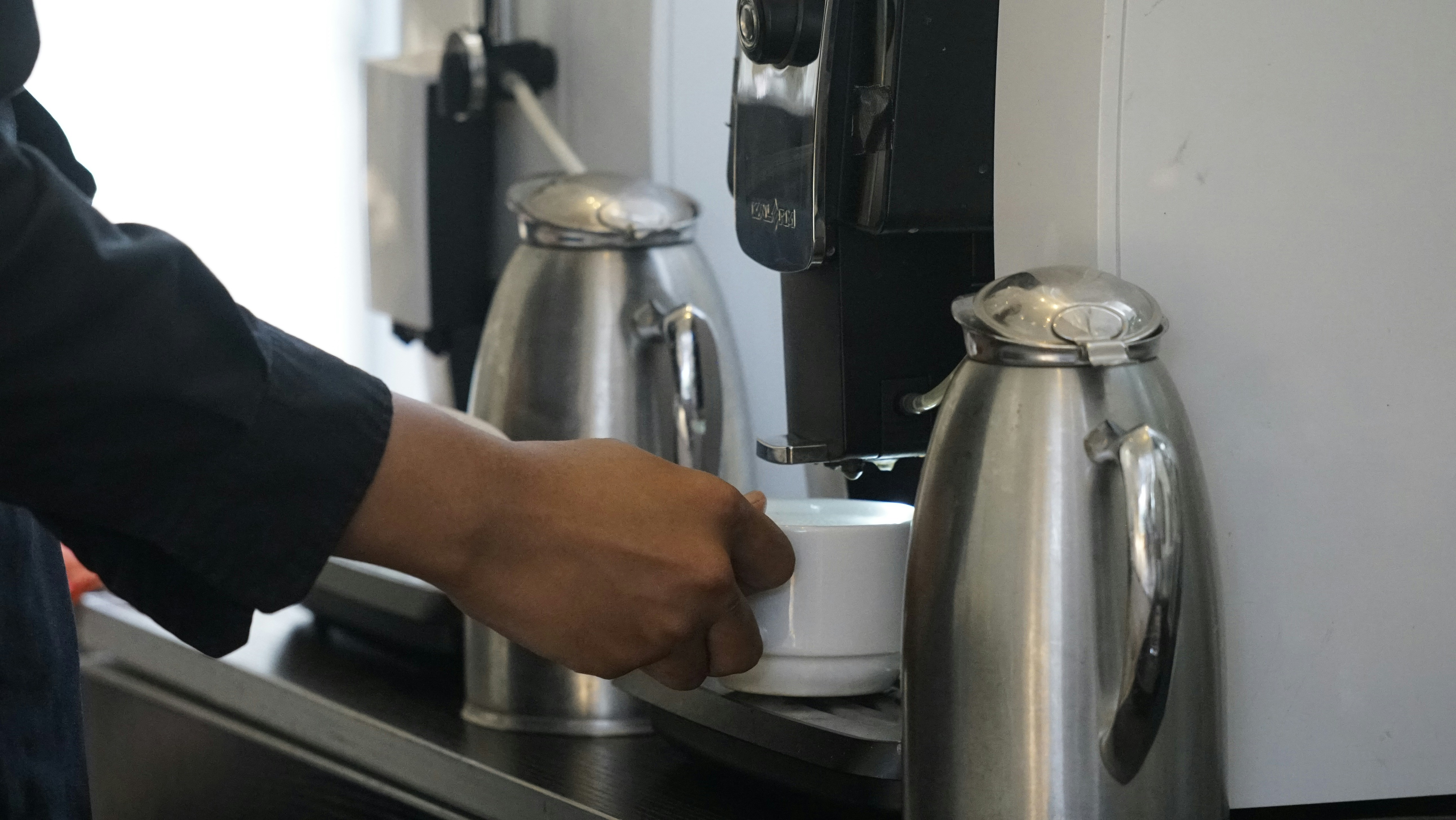 A close up of a person using a coffee maker photo – Free Adult Image on ...