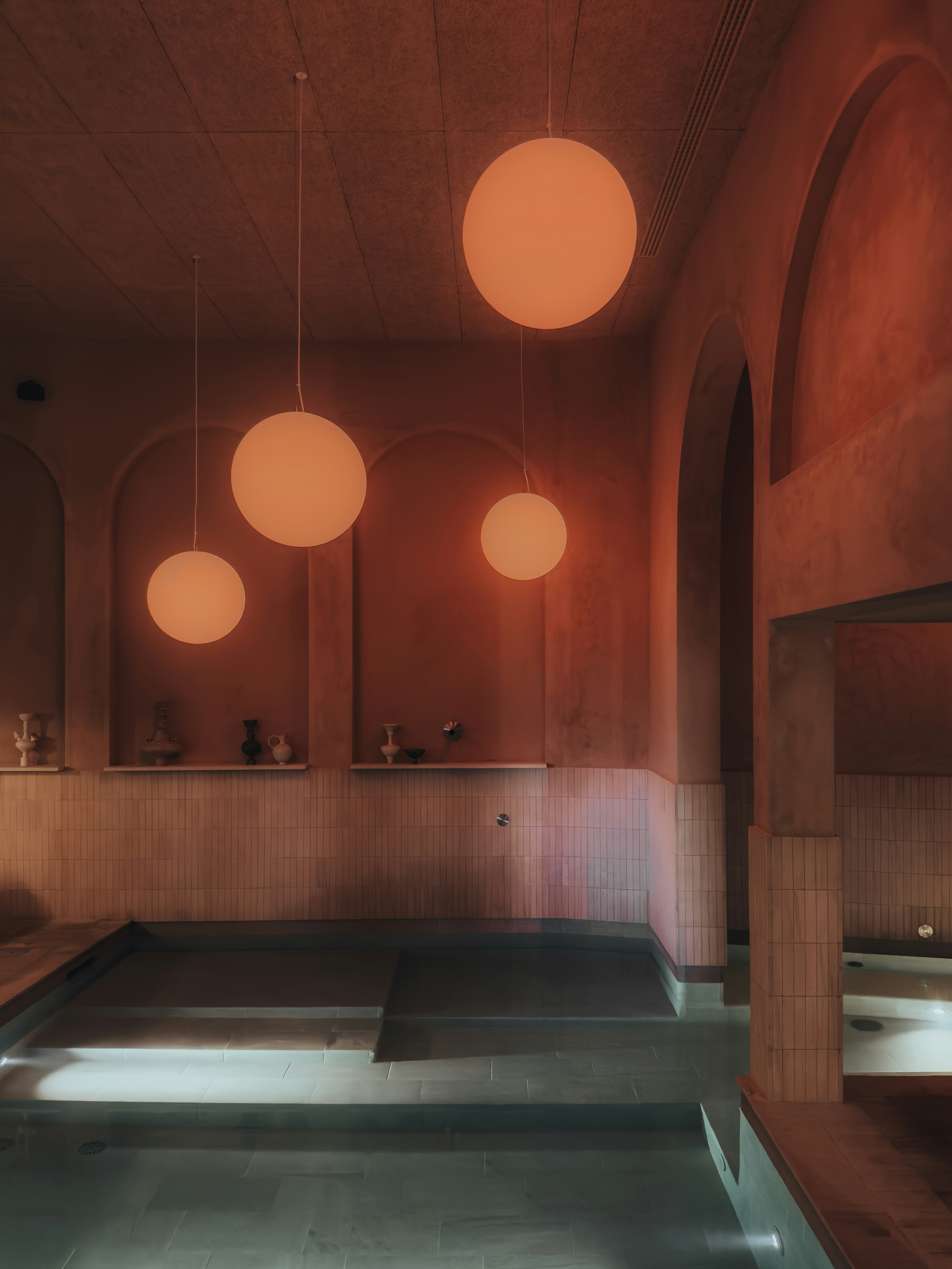 A large swimming pool with lights hanging from the ceiling photo – Free ...