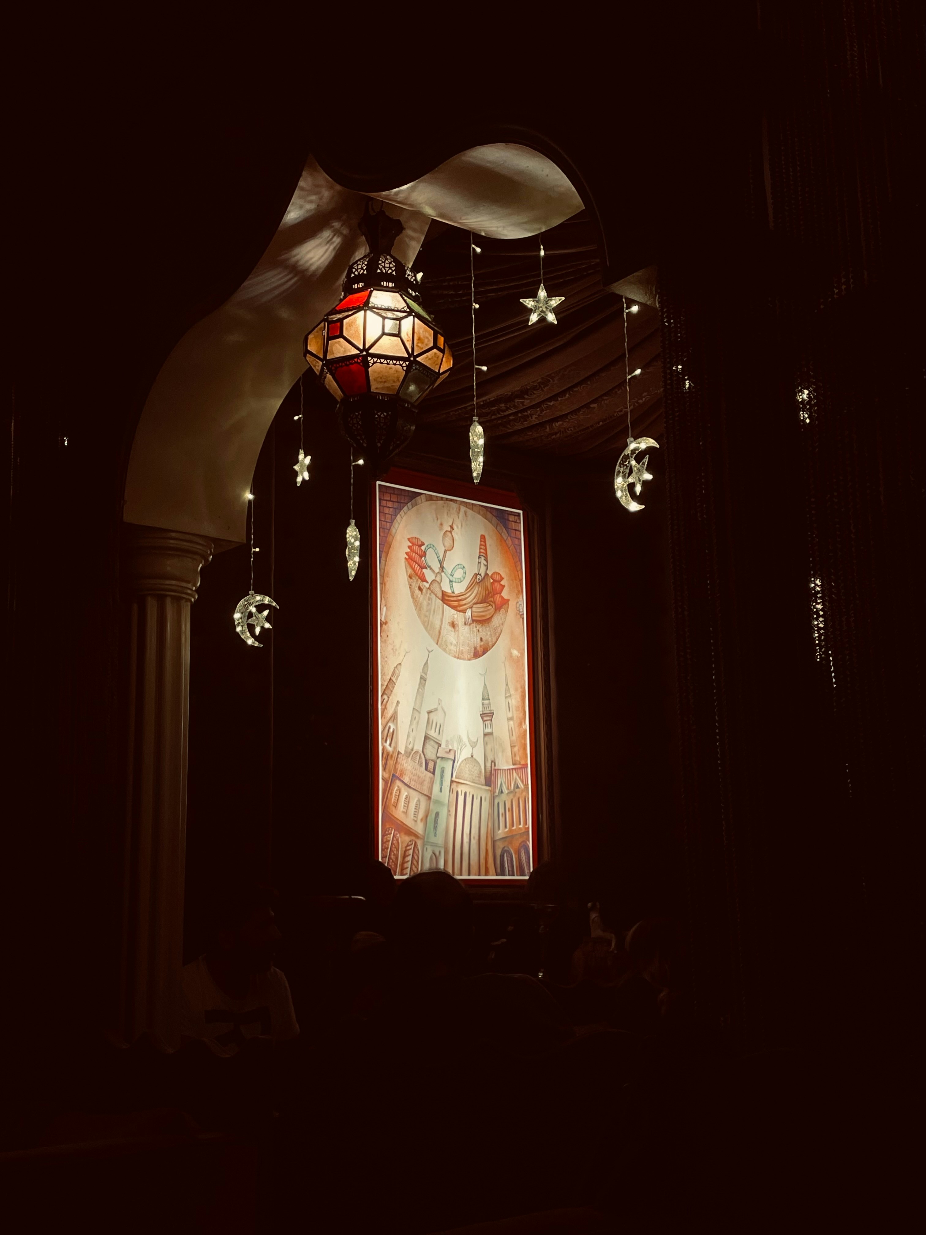 Lanterns and Stars: A Dim Hall Frames a Warm Cityscape Poster