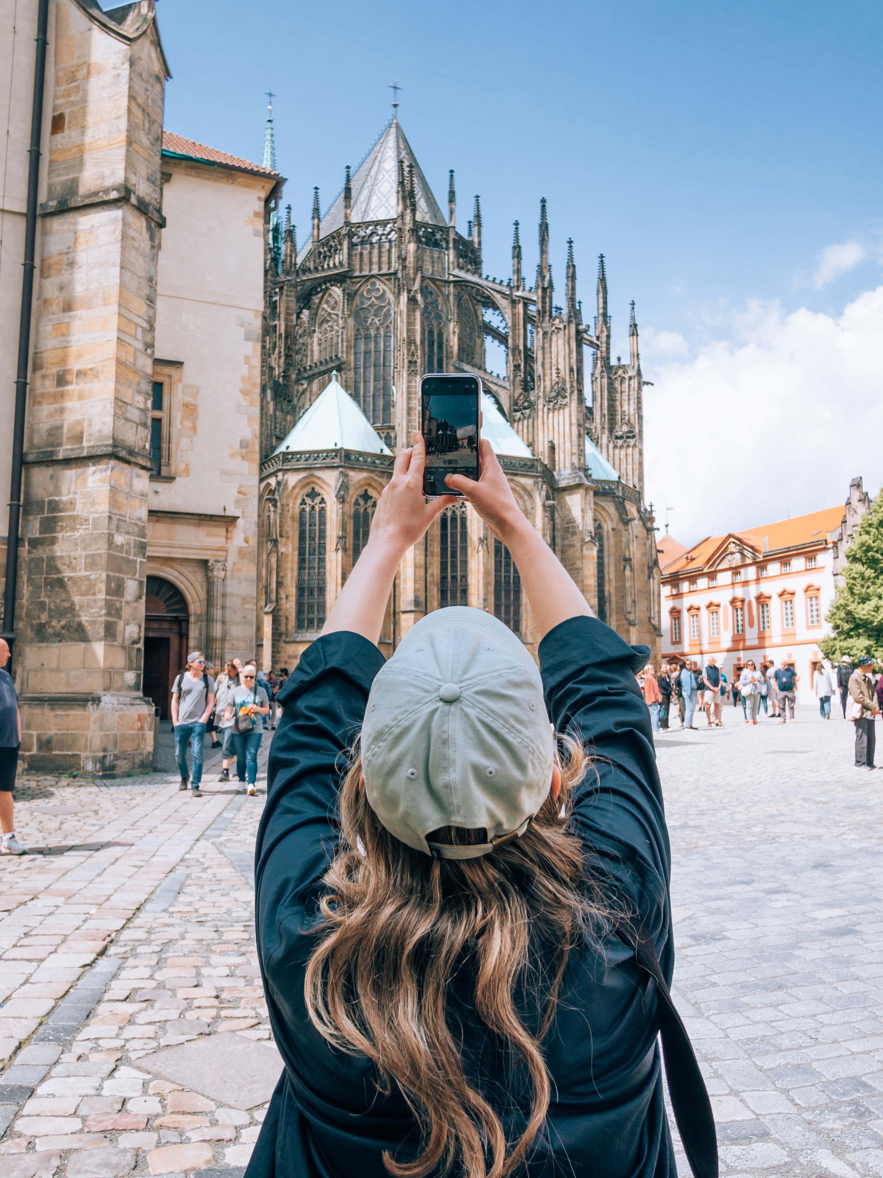 a woman taking a picture of a cathedral