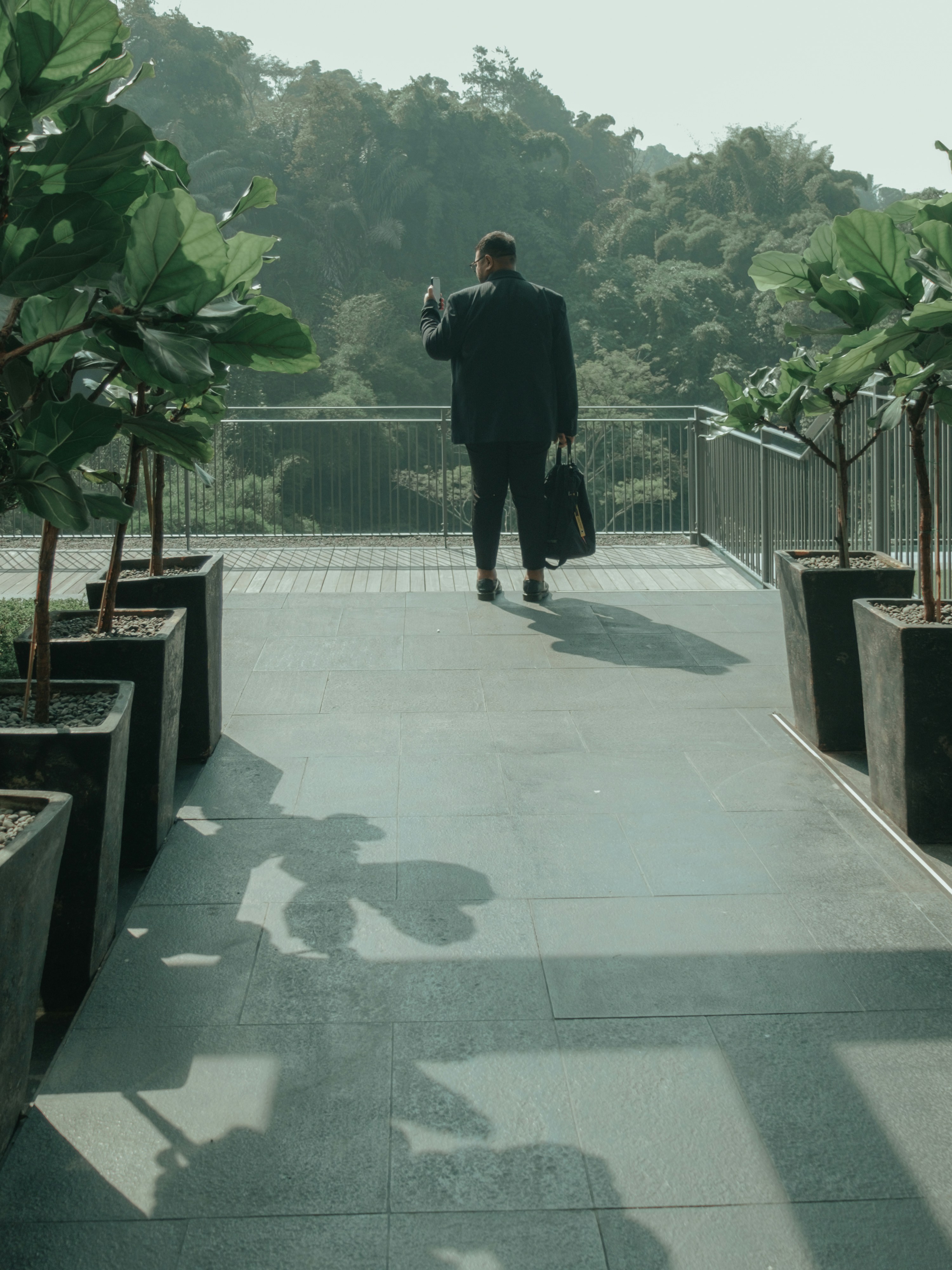 A man in a suit walking down a walkway photo – Free Bandung Image on ...