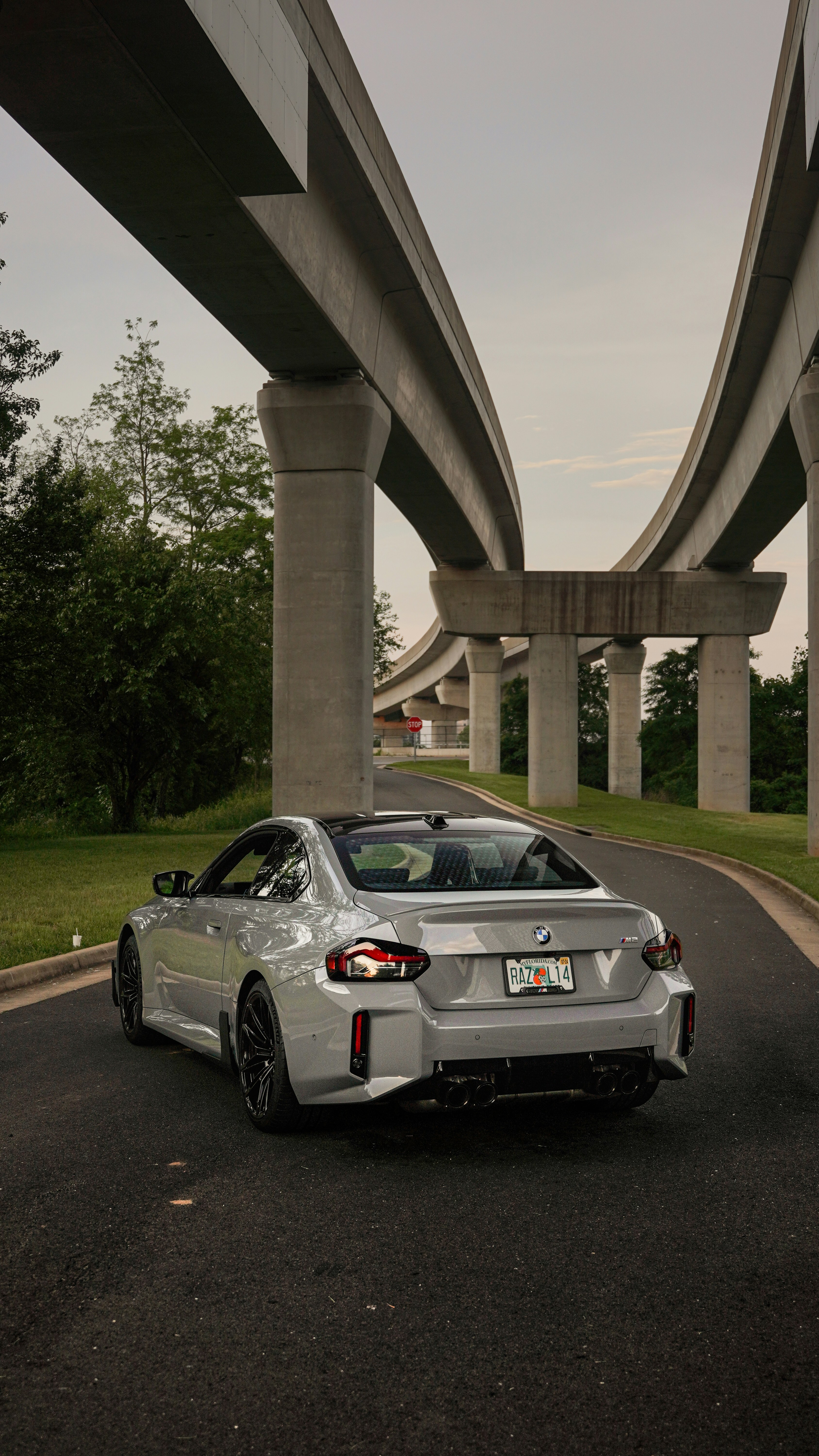 A silver sports car driving under a bridge photo – Free Sports car ...