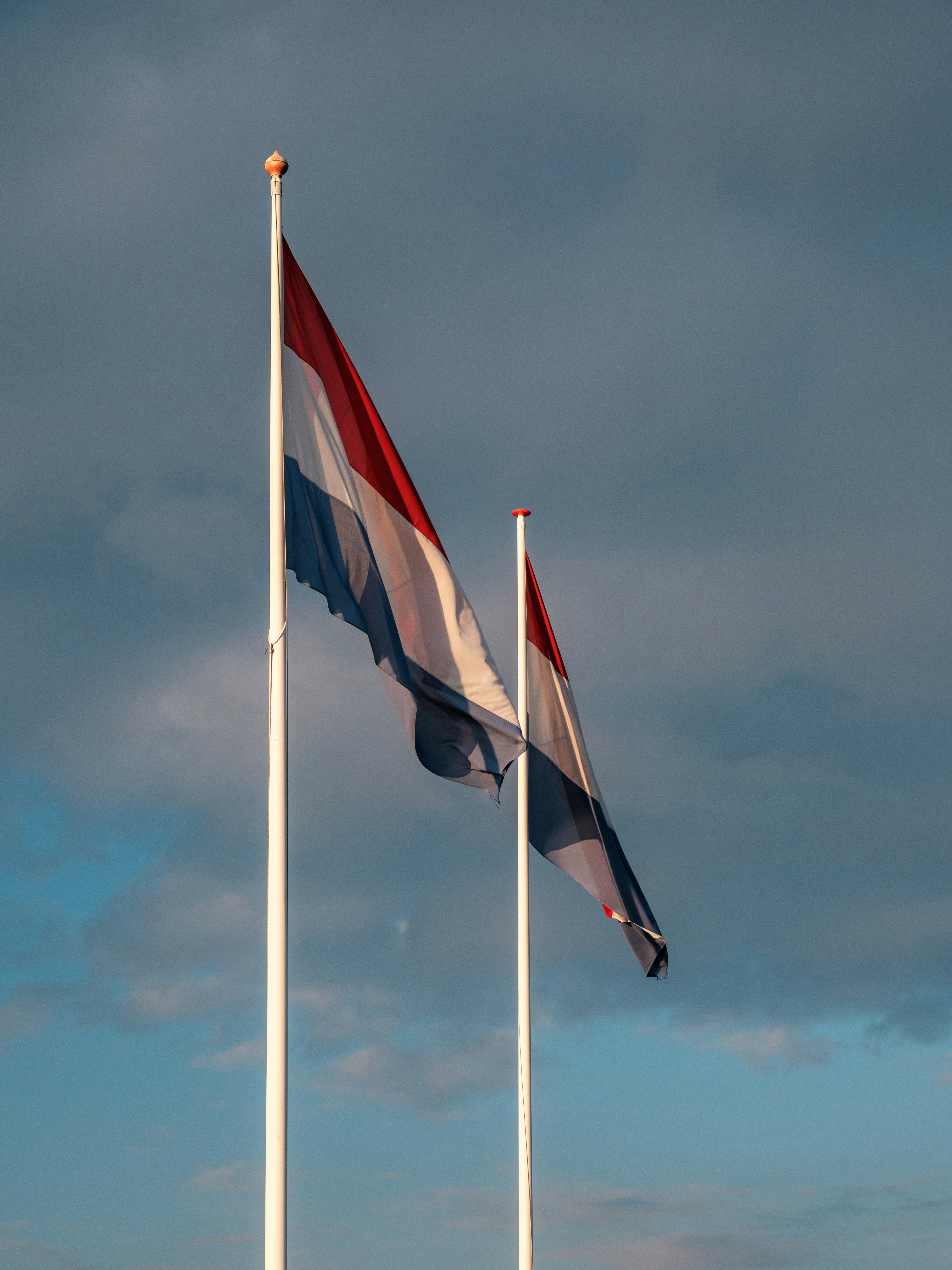 A couple of flags that are next to each other photo – Free Netherlands ...