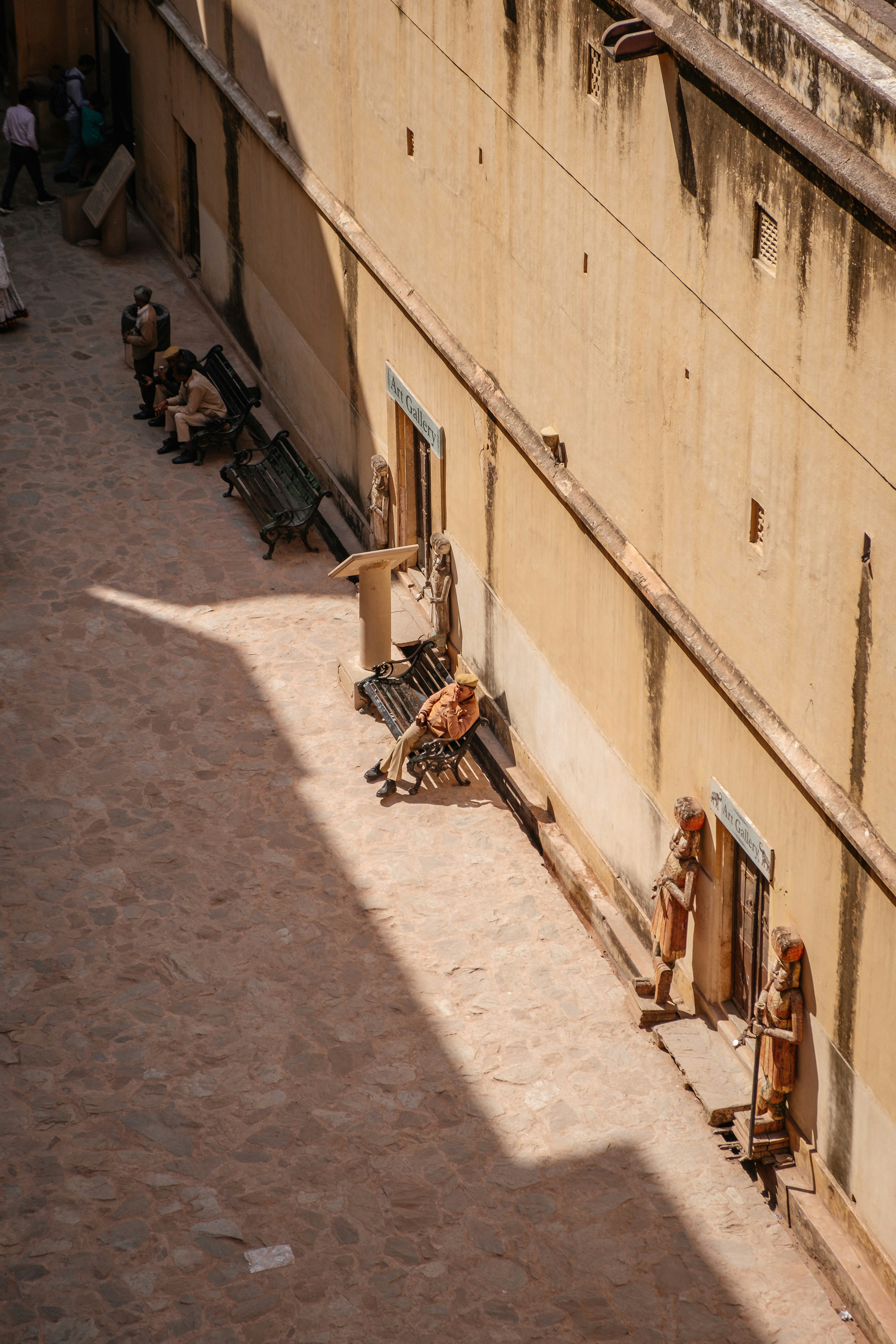 Echoes in the Sun: A Walled Alley Framed by Shadow