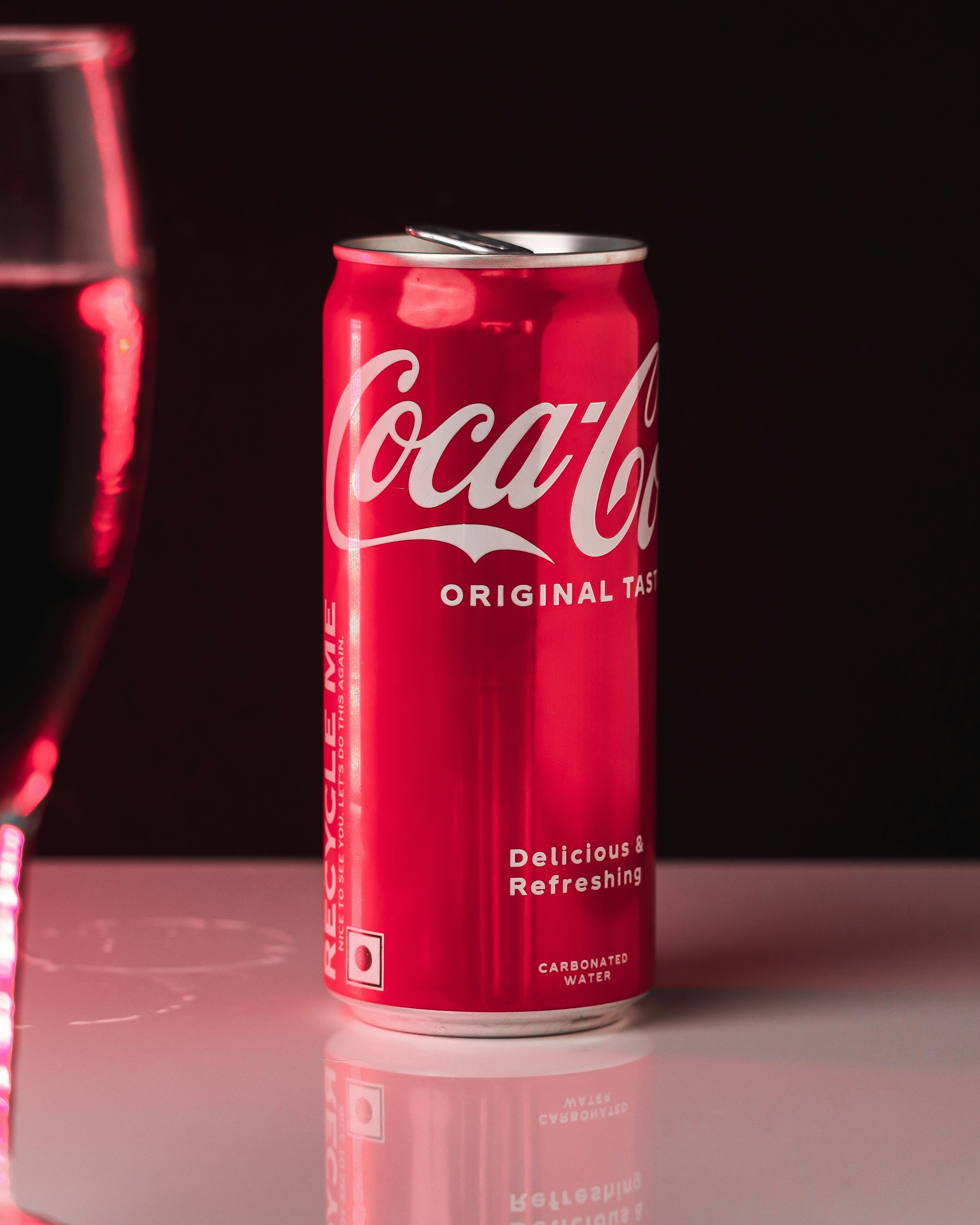 A can of coca cola next to a glass of red wine photo – Free Red Image ...